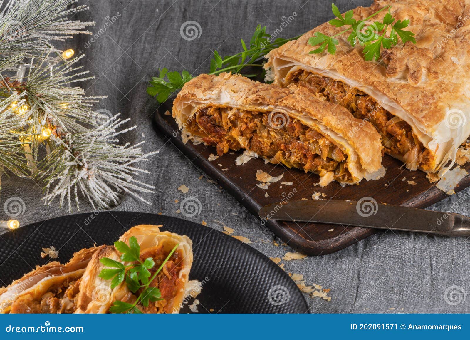Puff Pastry Vegetable Roll on Kitchen Table with Christmas Decorated ...