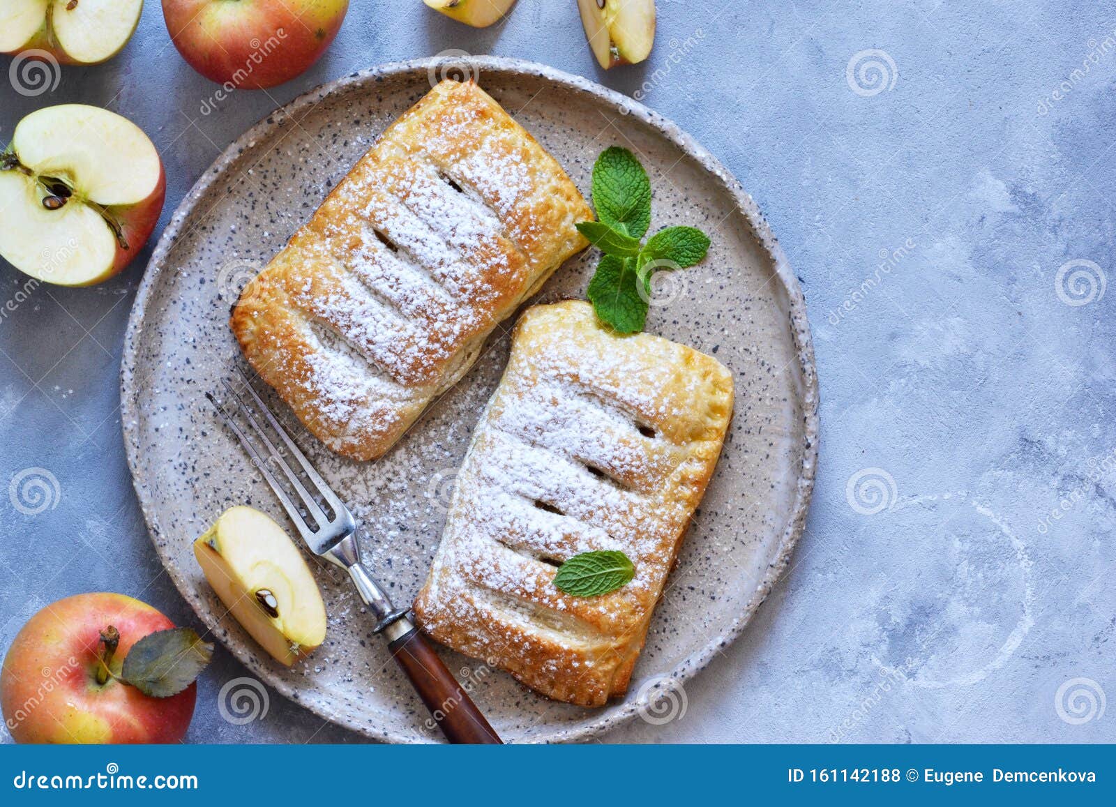 Puffs with Apples and Cinnamon in a Plate on the Kitchen Table. View ...