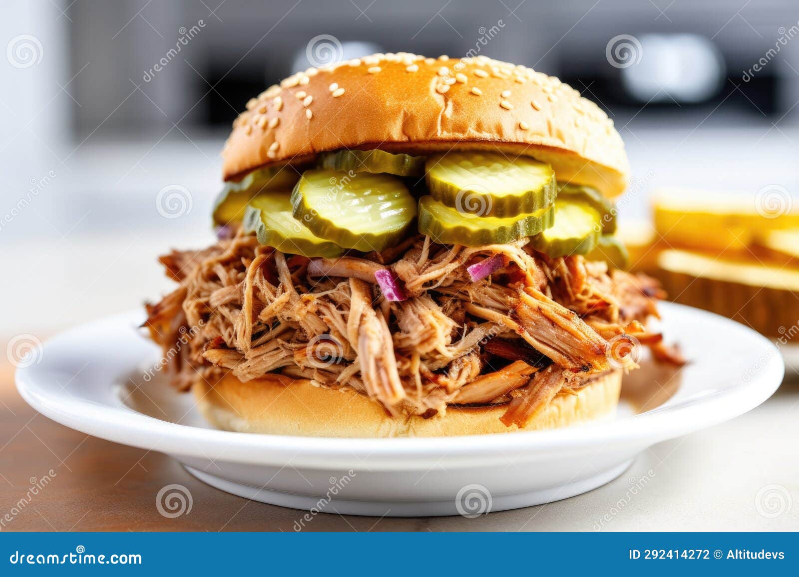 Pulled Pork Sandwich Stacked with Pickles on a White Plate Stock Photo ...