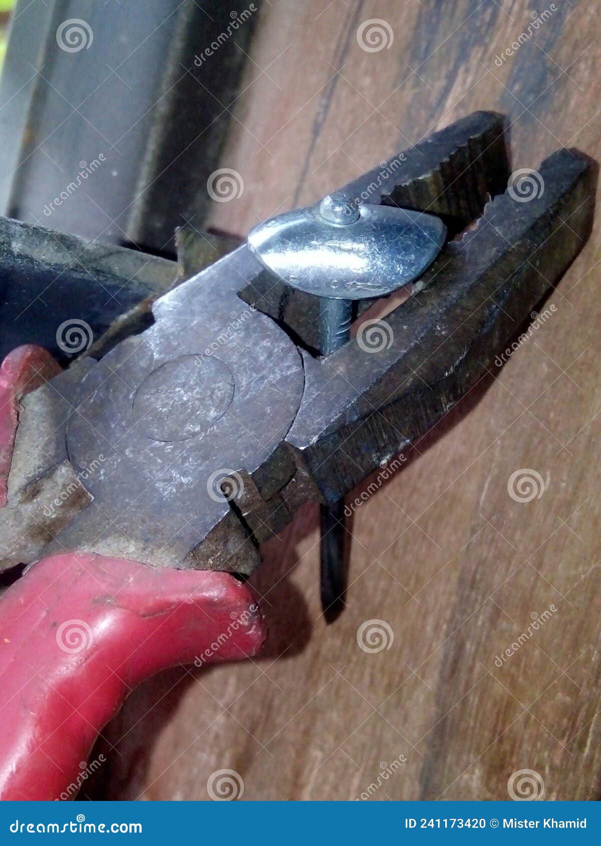 Pulling Nails from Wood Using Combination Pliers Stock Photo - Image of ...