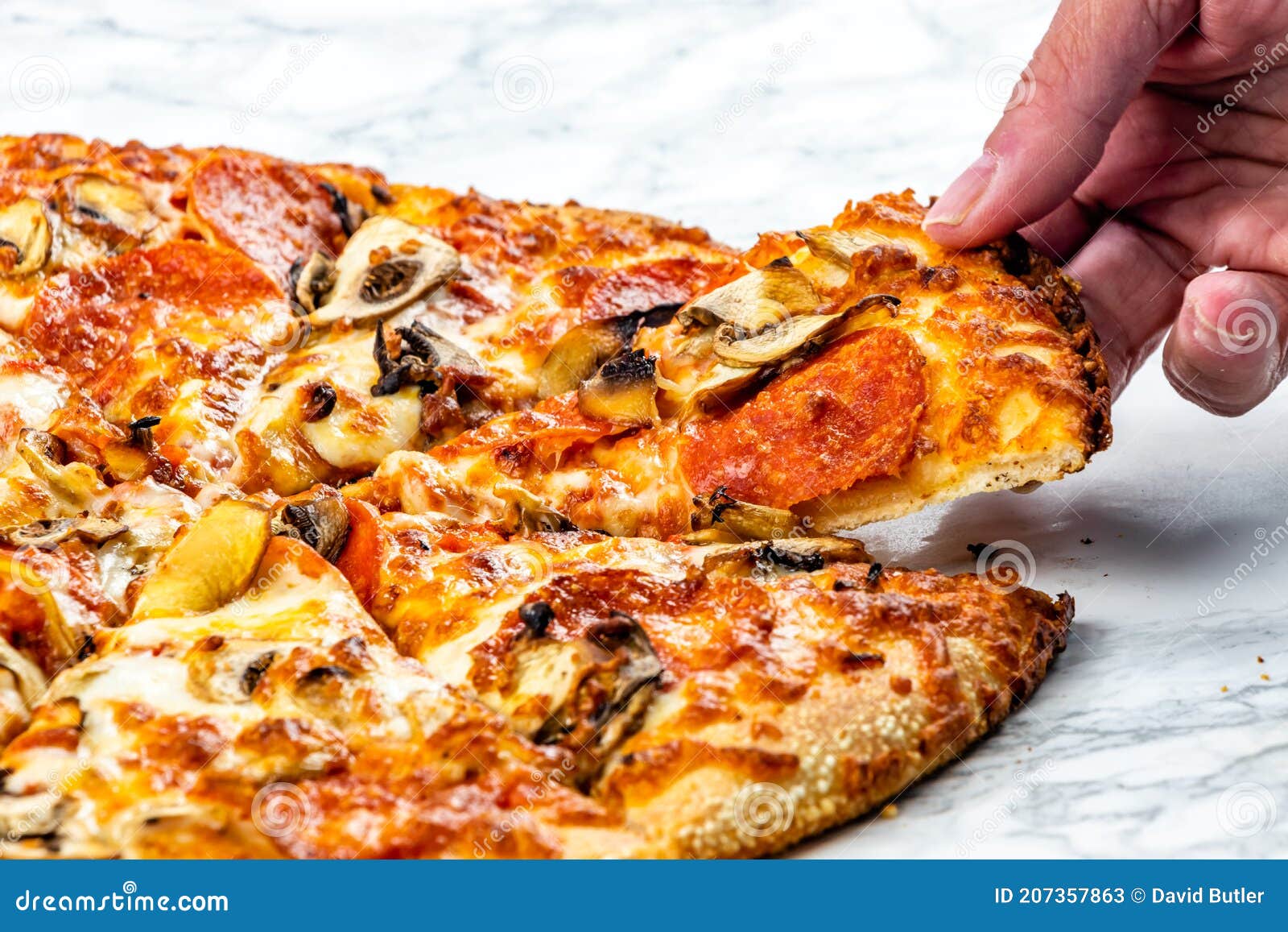 Pulling Out a Slice of Pepperoni and Mushroom Pizza. Calgary Alberta ...