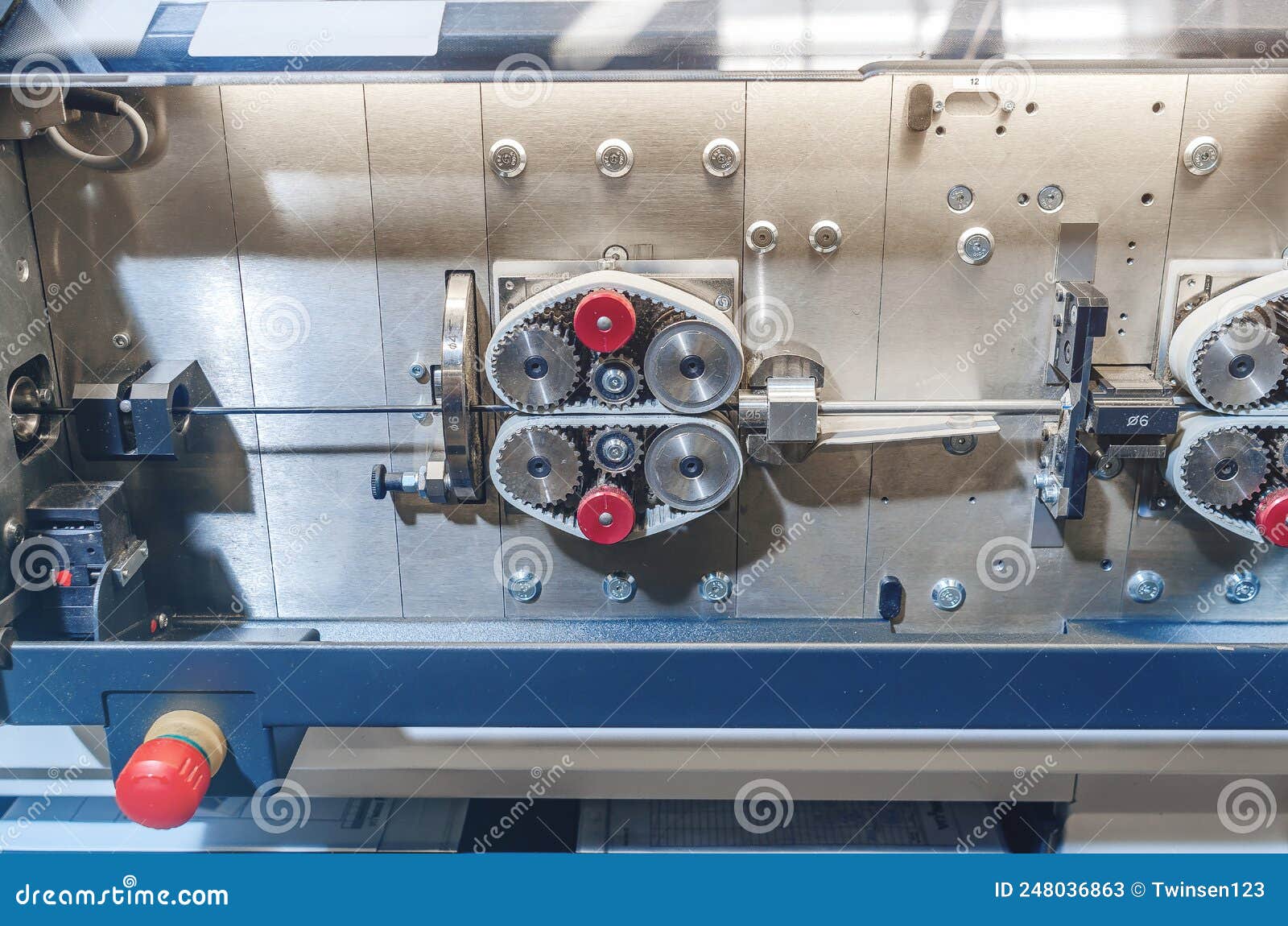Pulling the Wire through the Gears on the Machine. Part of Industrial ...