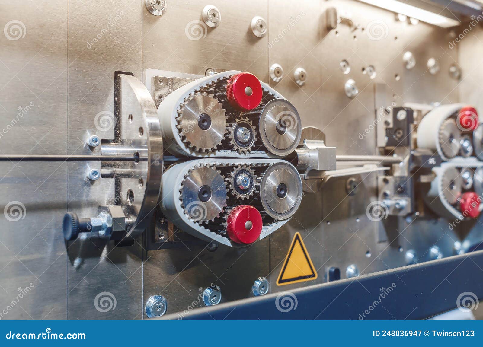 Pulling the Wire through the Gears on the Machine. Part of Industrial ...