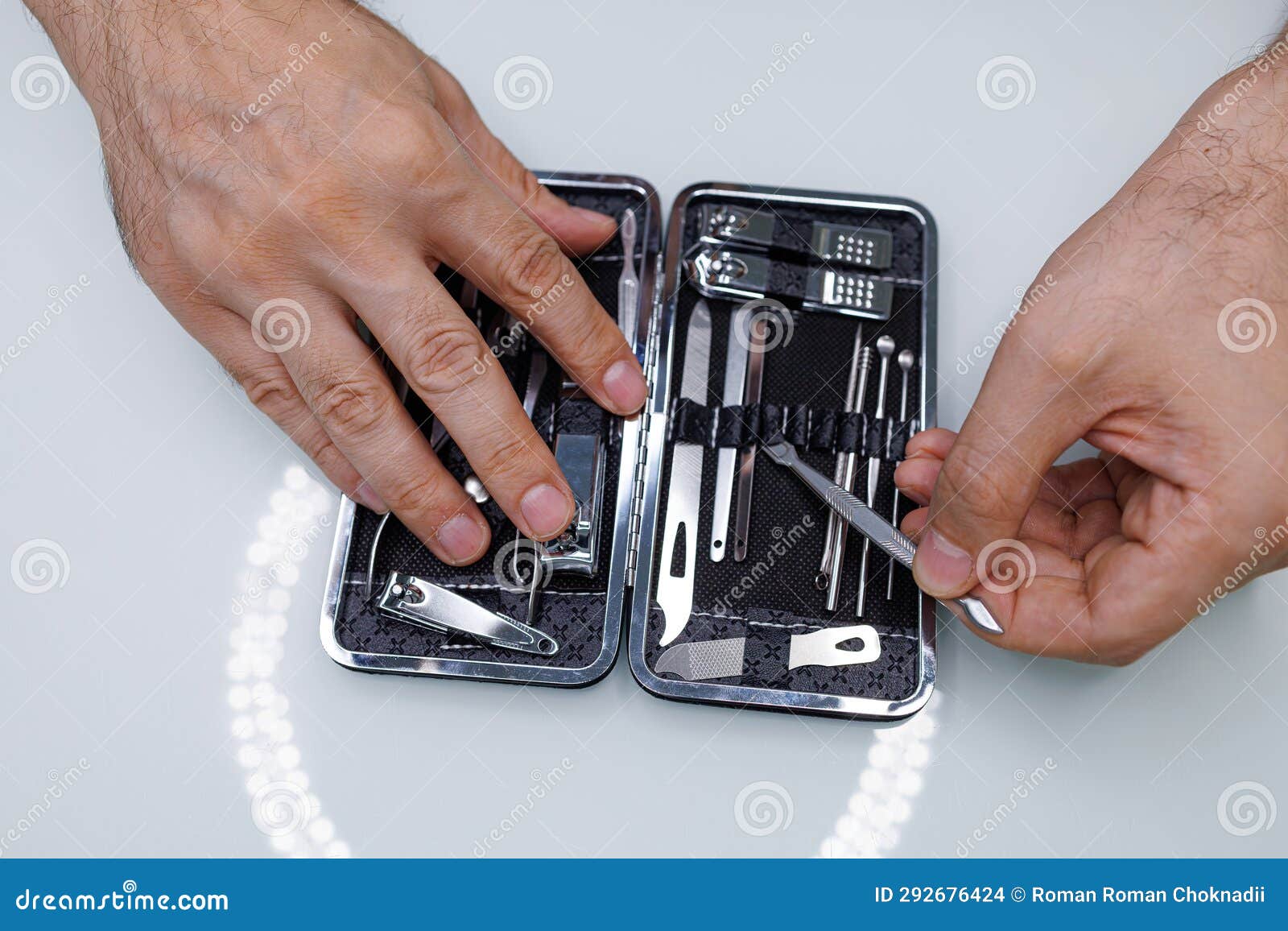 Pulls Out a Nail Tool from the Kit. a Man Gives Himself a Manicure ...