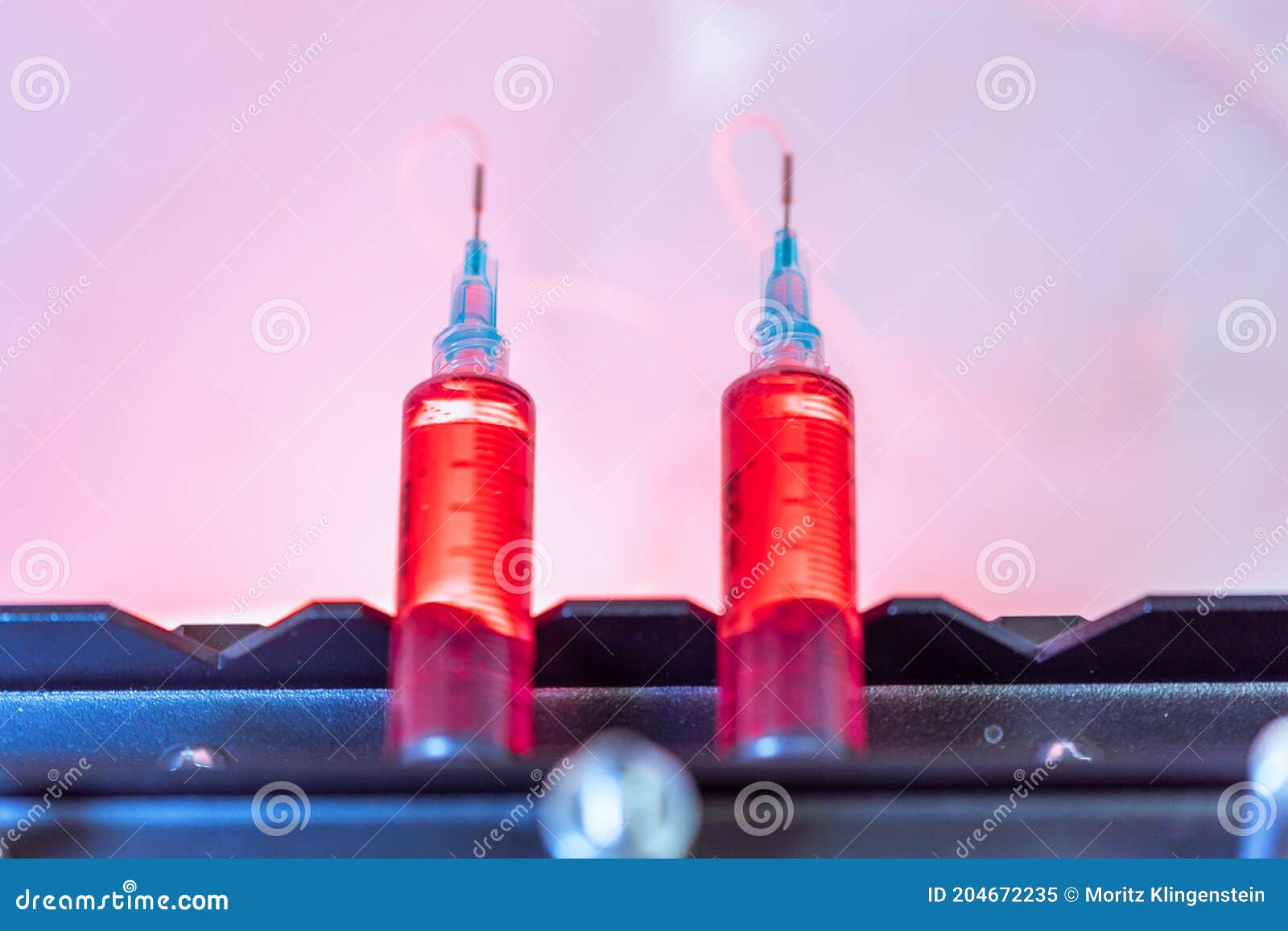 Pump Pushing Red Liquid Medium through Syringes and Flexible Tubes in a ...