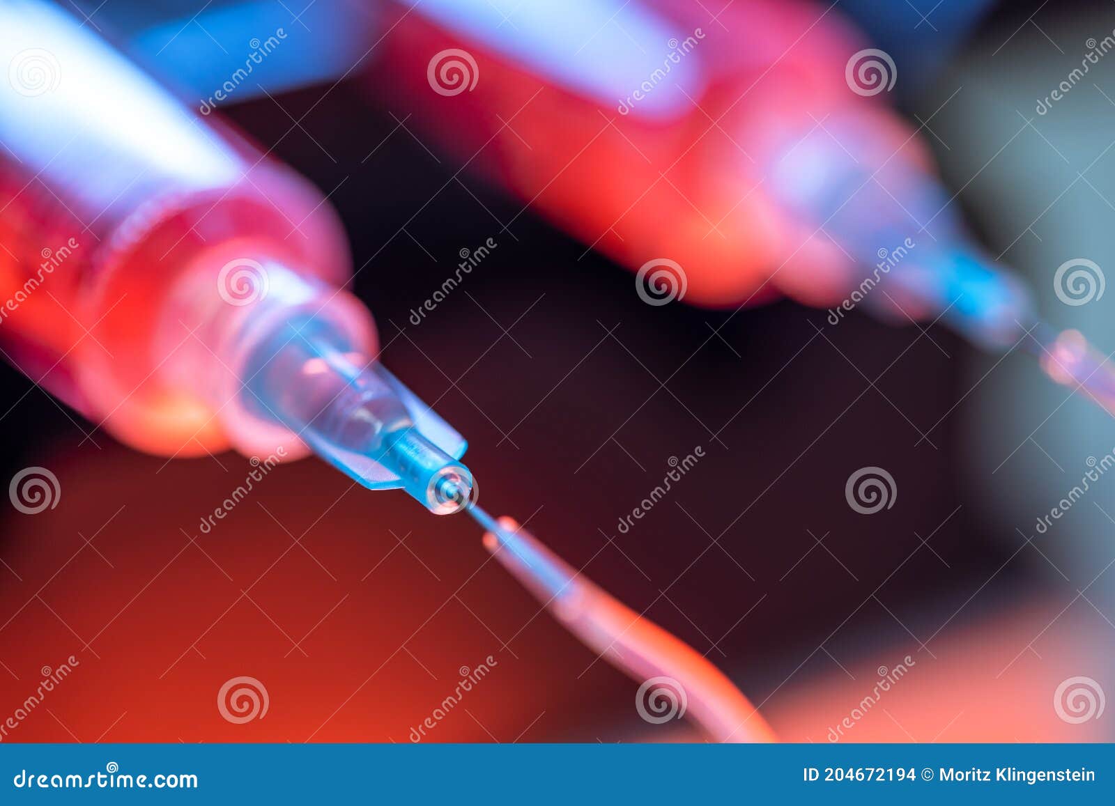Pump Pushing Red Liquid Medium through Syringes and Flexible Tubes in a ...
