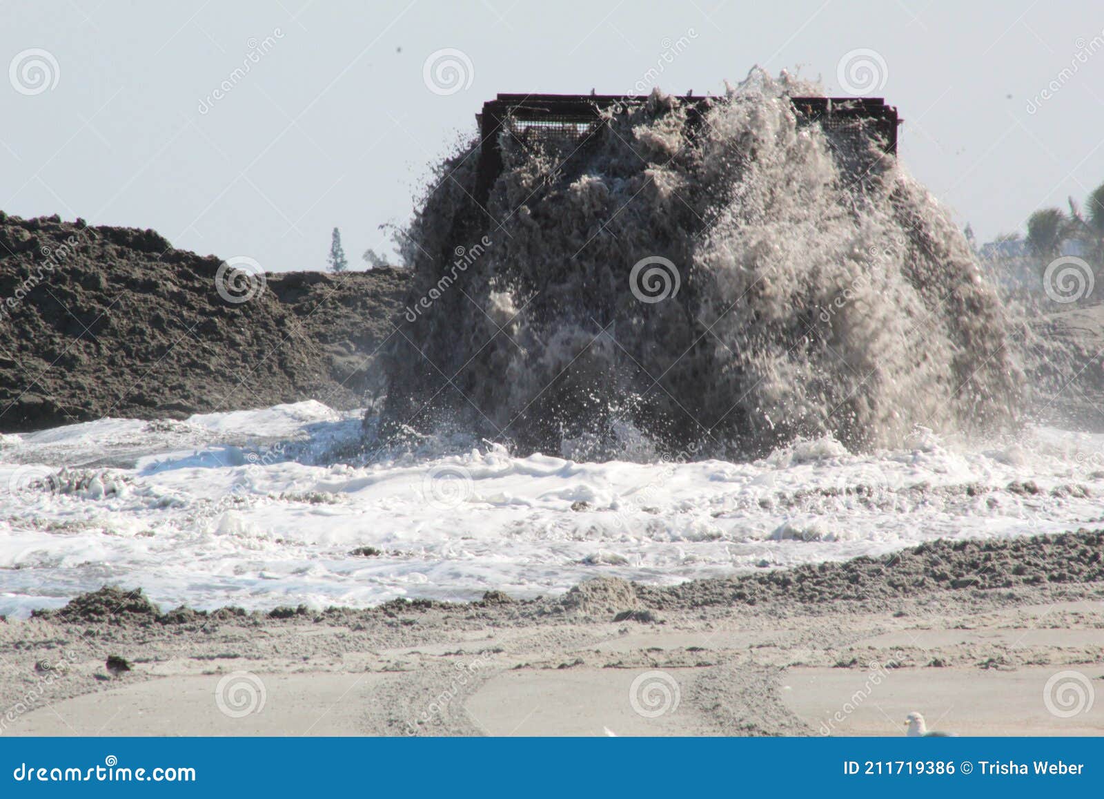 Pumping in sand on beach stock photo. Image of wind - 211719386