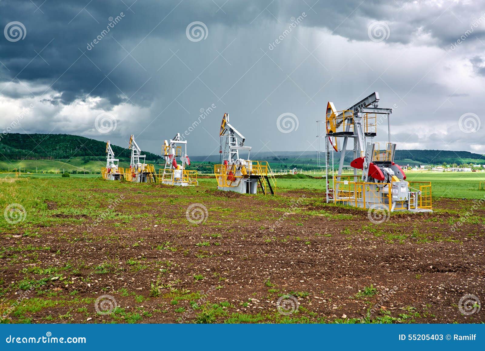 Pumping Unit for Pumping Oil on a Background of Cumulus Clouds and ...