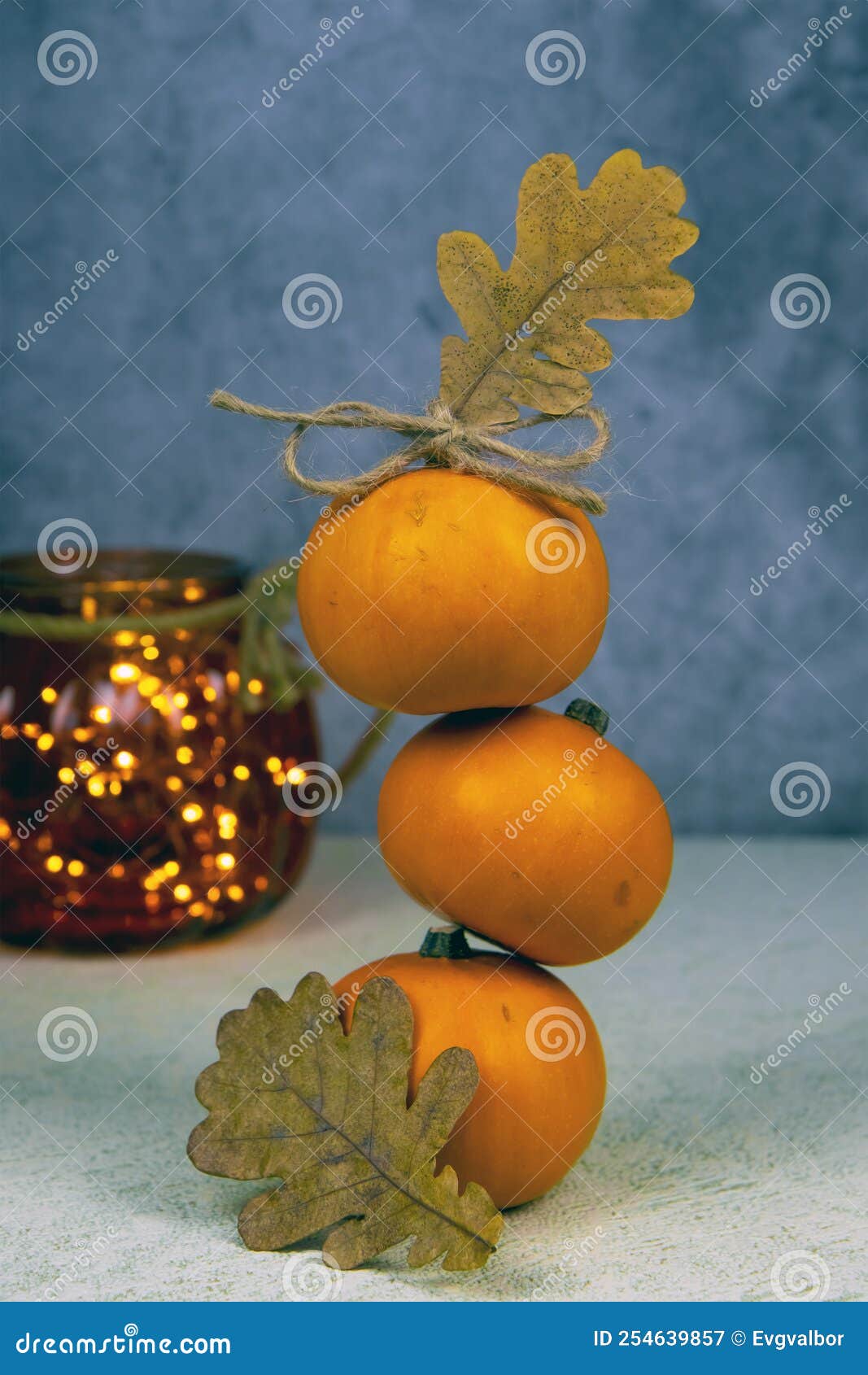 Three Small Bright Orange Pumpkins Stacked on Top of Each Other Against ...