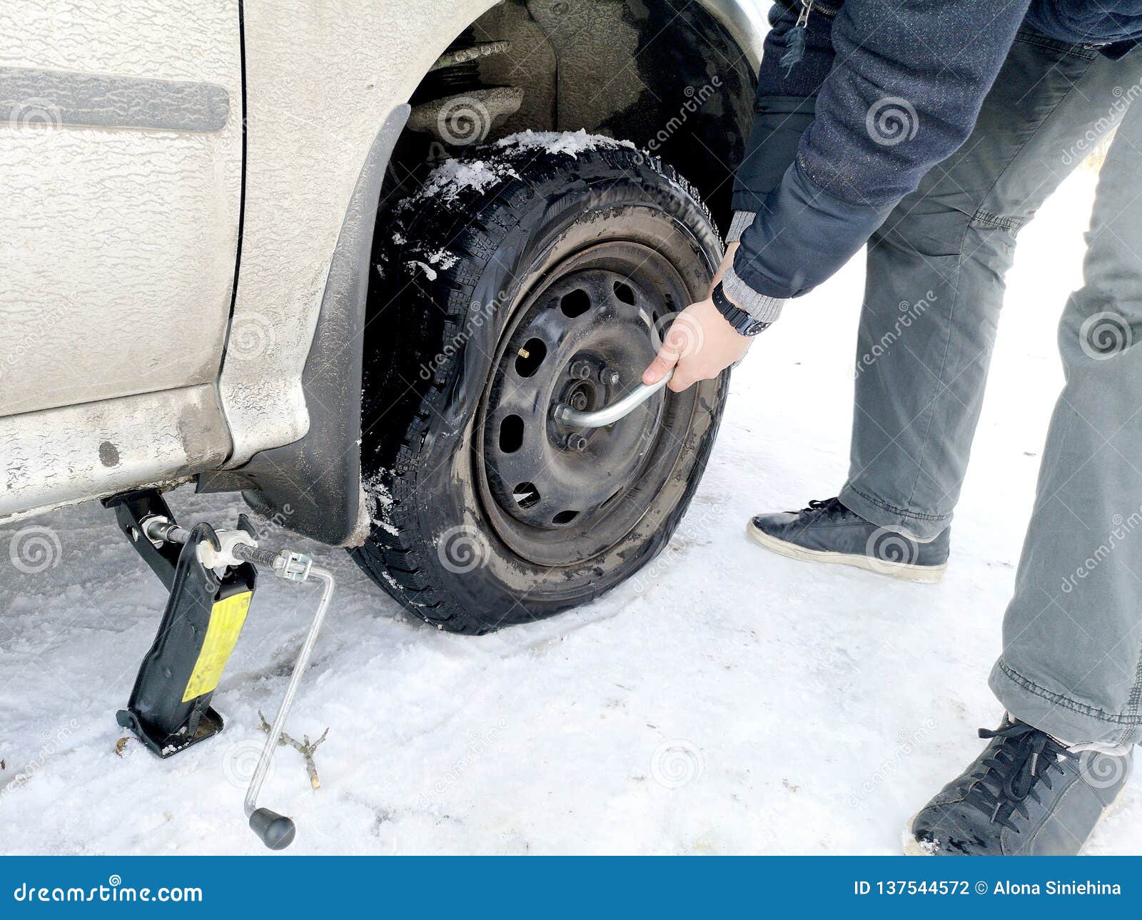 Punched and Flat Tire on the Road. Replacing the Wheel with a Jack by ...