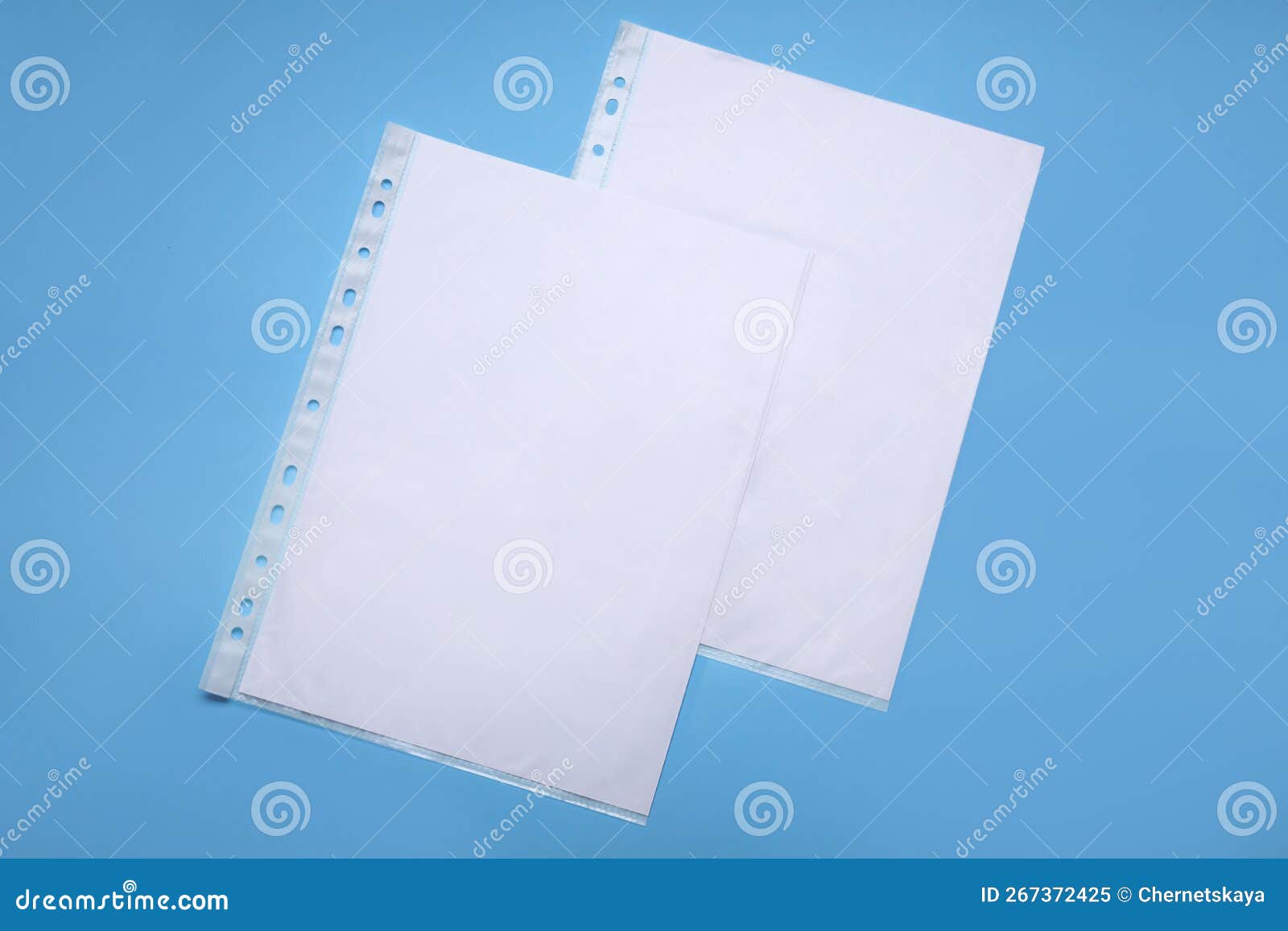 Punched Pockets with Paper Sheets on Light Blue Background, Flat Lay ...