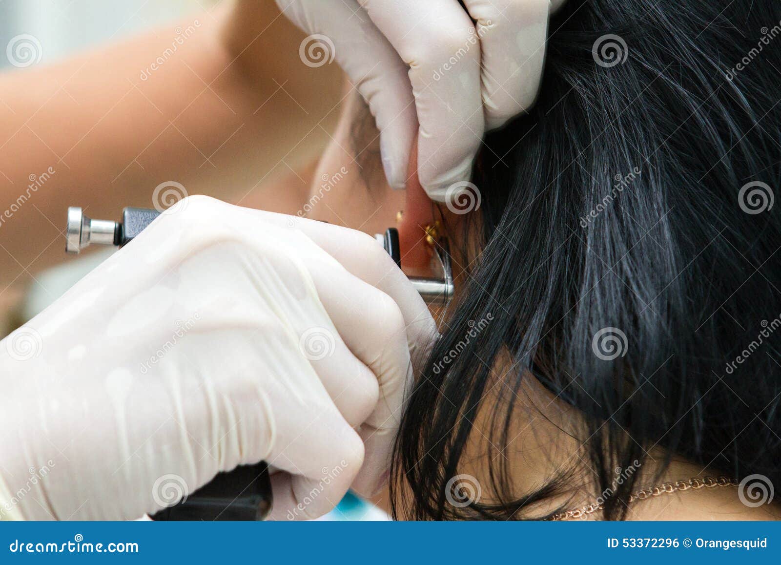 Puncture of the ear stock photo. Image of model, hand - 53372296