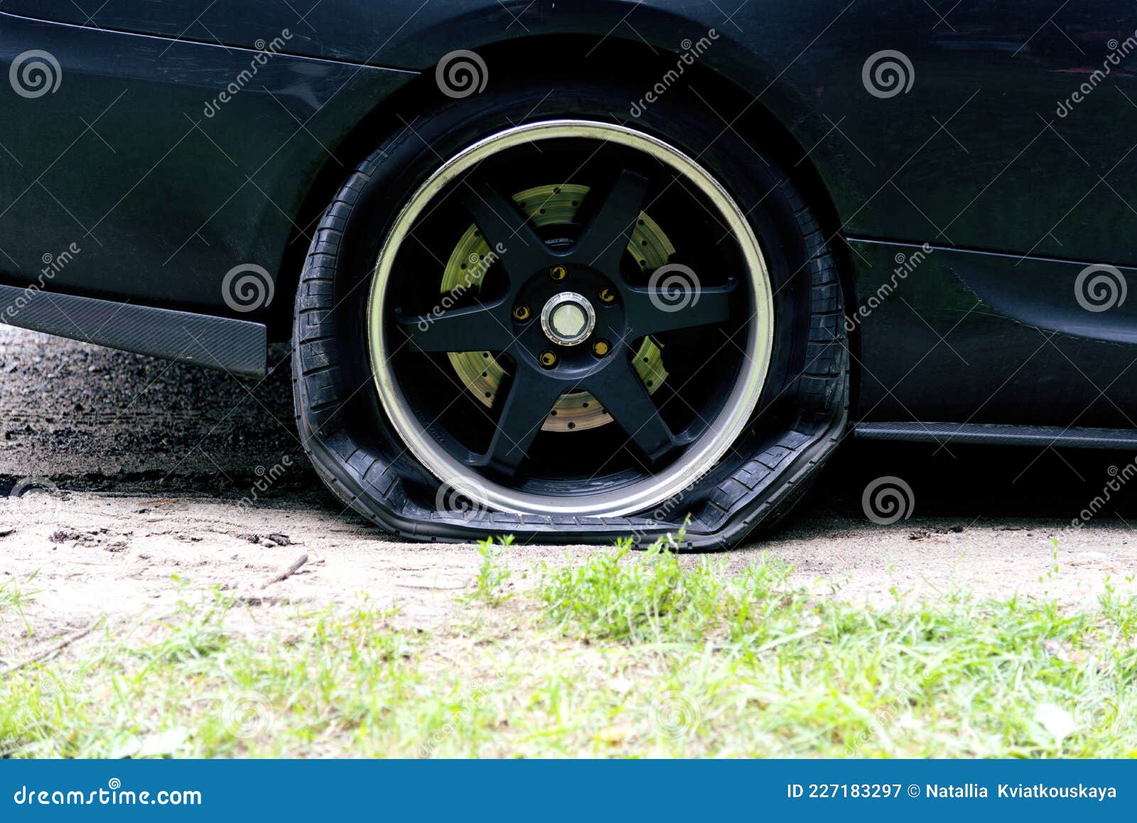 Punctured Wheel of a Modern Car on the Road. Car Tire Puncture Stock ...