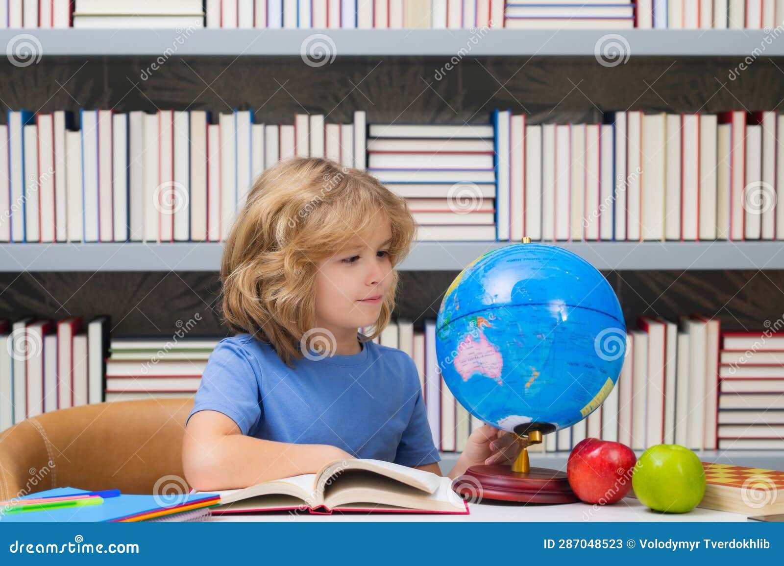 Pupil Looking at Globe in Library at the Elementary School. Nerd School ...