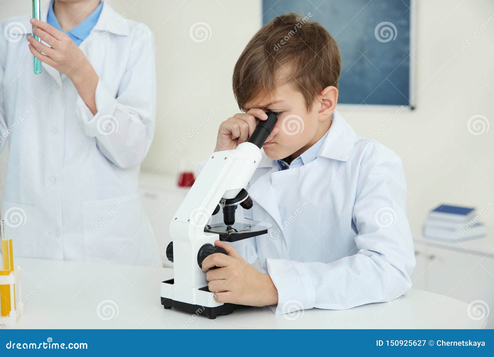 Pupil Looking through Microscope in Chemistry Class Stock Image - Image ...