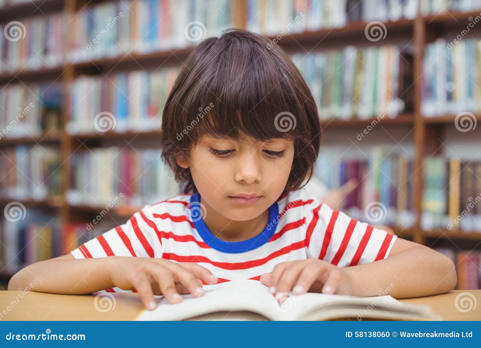 Pupil Reading Book at Desk in Library Stock Photo - Image of academic ...