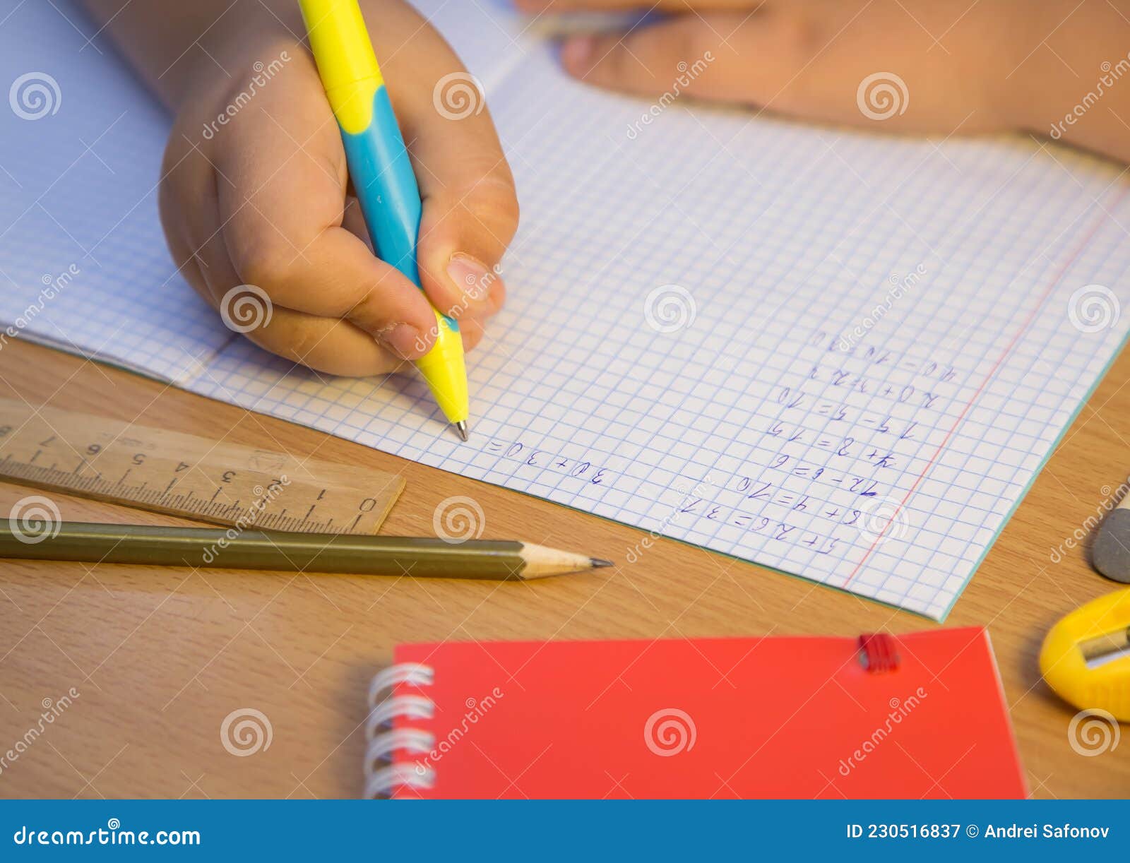 Pupil S Hand Close-up Solves Math Examples with a Ballpoint Pen. Stock ...