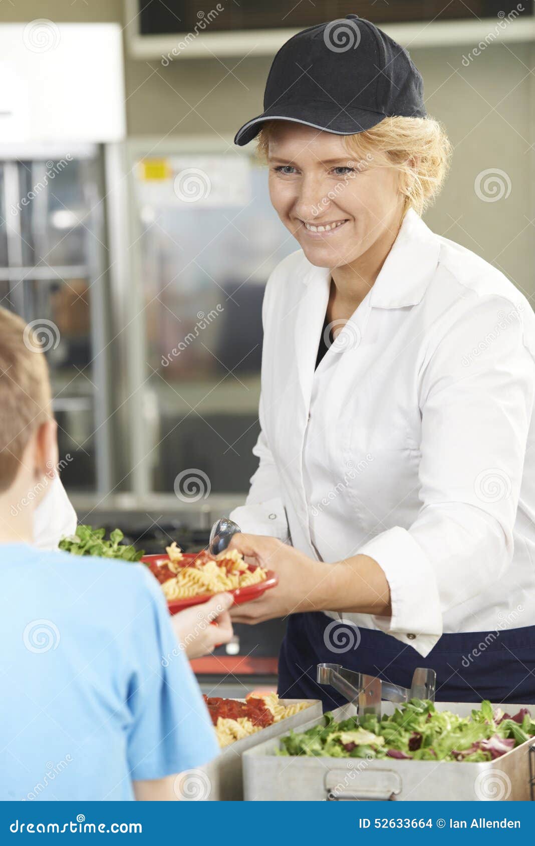 Pupil in School Cafeteria Being Served Lunch by Dinner Lady Stock Photo ...