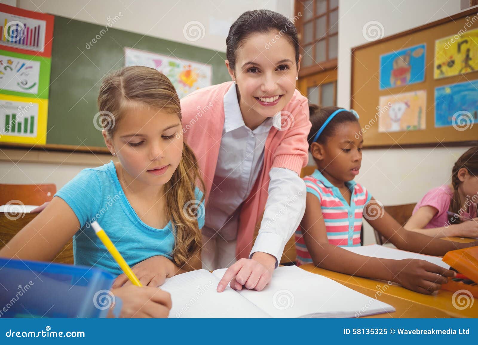 Pupil and Teacher at Desk in Classroom Stock Image - Image of lesson ...