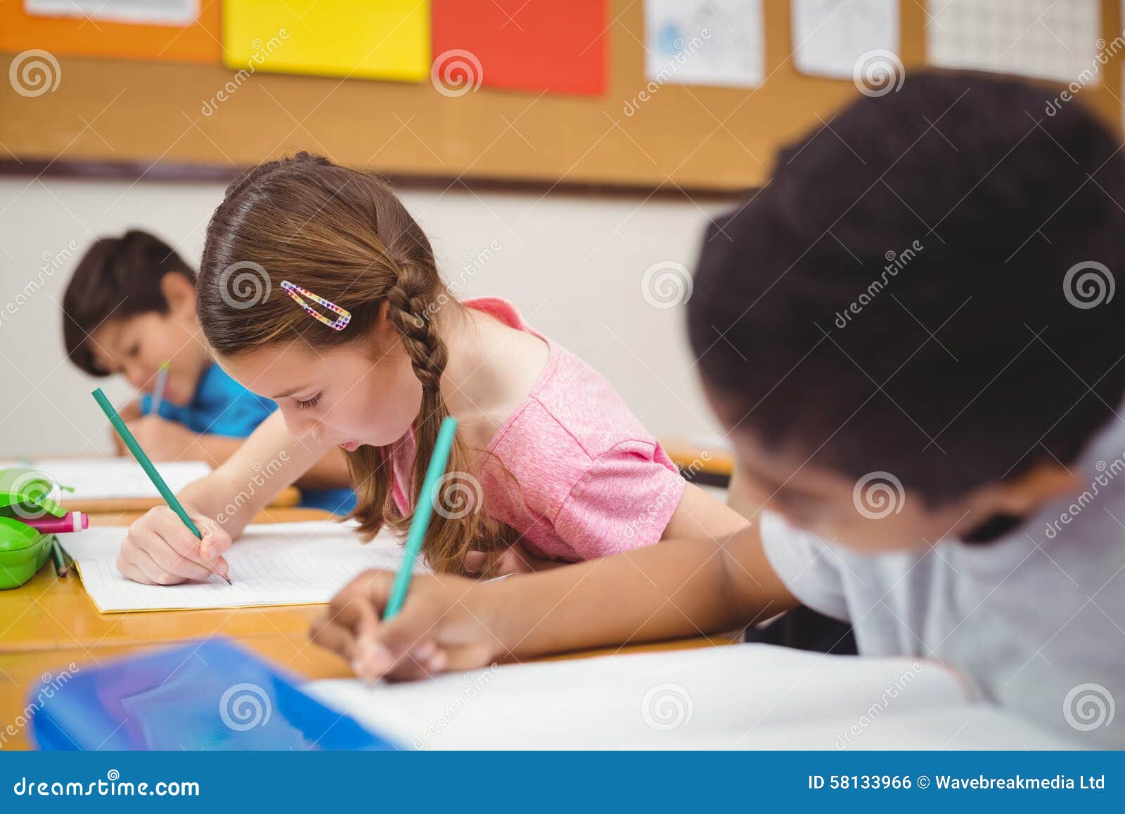 Pupil working at her desk stock photo. Image of elementary - 58133966