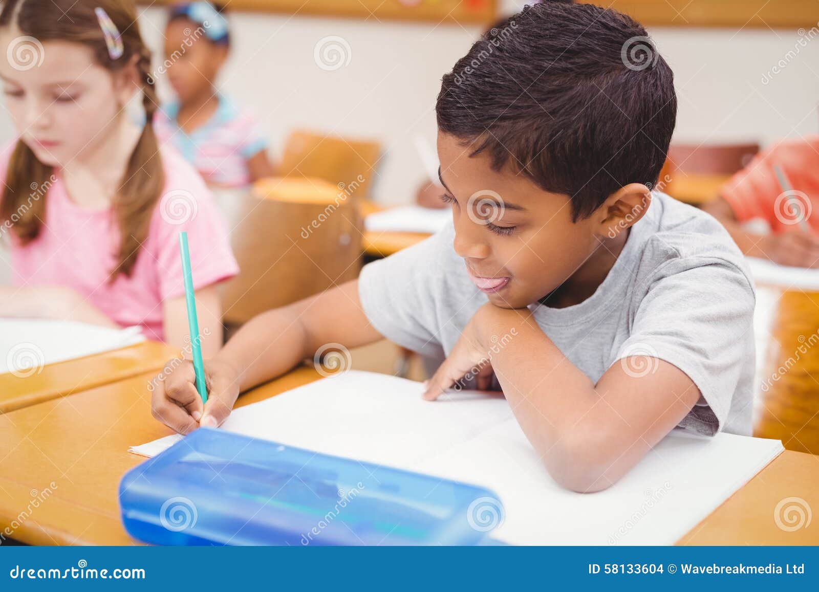 Pupil working at his desk stock photo. Image of early - 58133604