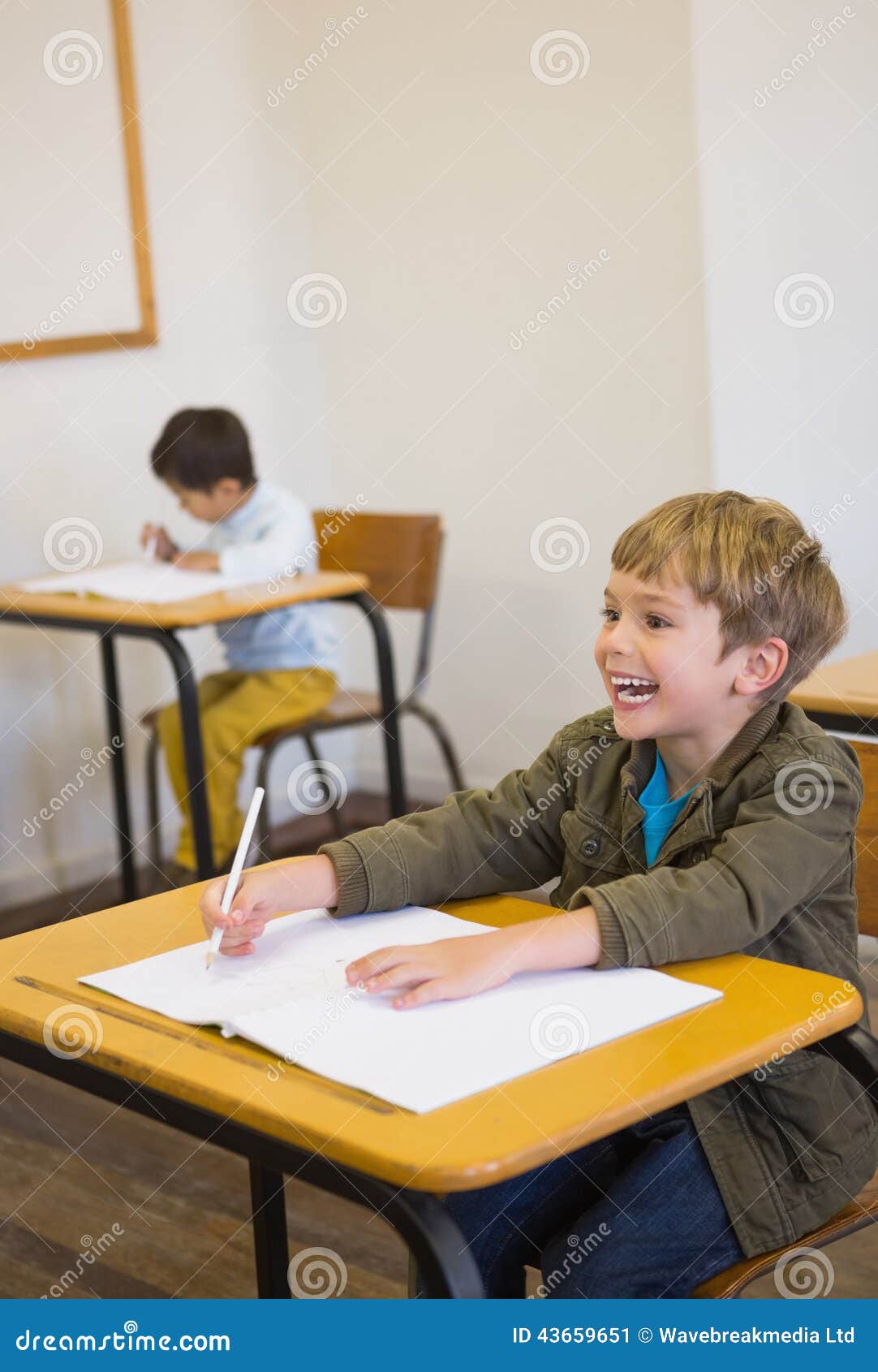 Pupil Writing in Notepad at His Desk Smiling Stock Image - Image of ...