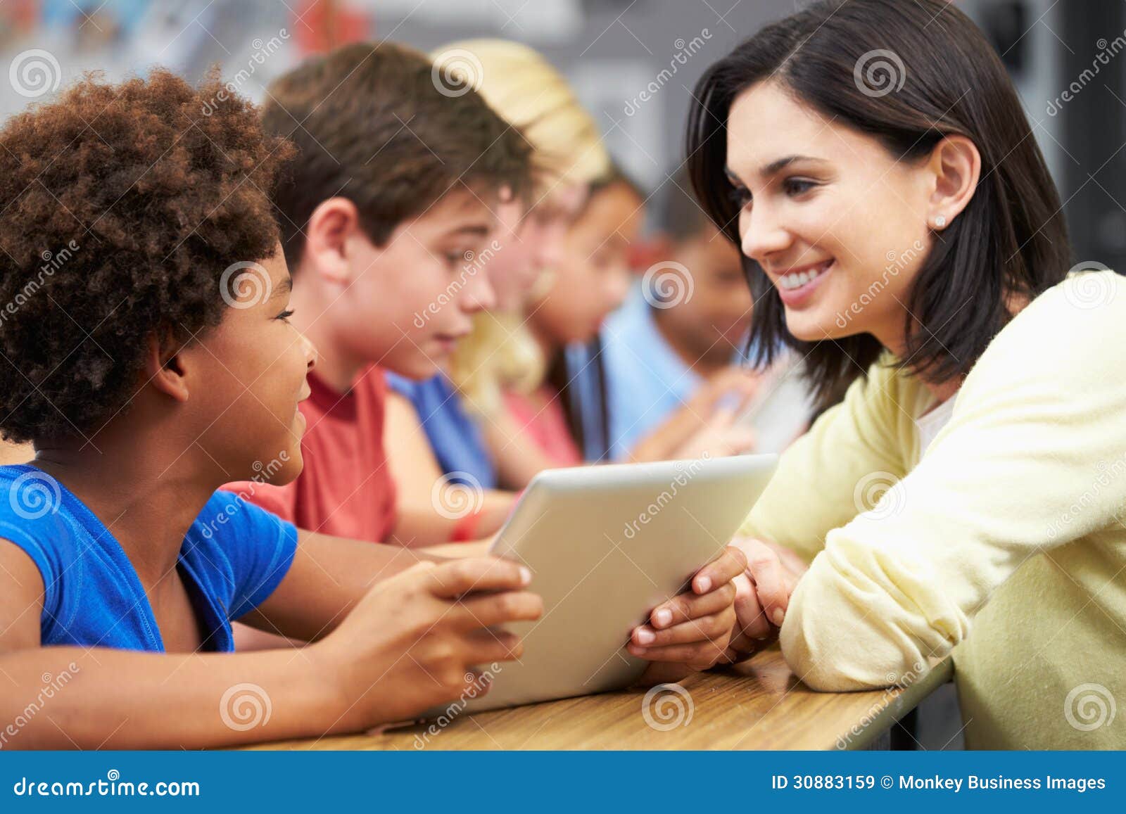 Pupils in Class Using Digital Tablet with Teacher Stock Image - Image ...