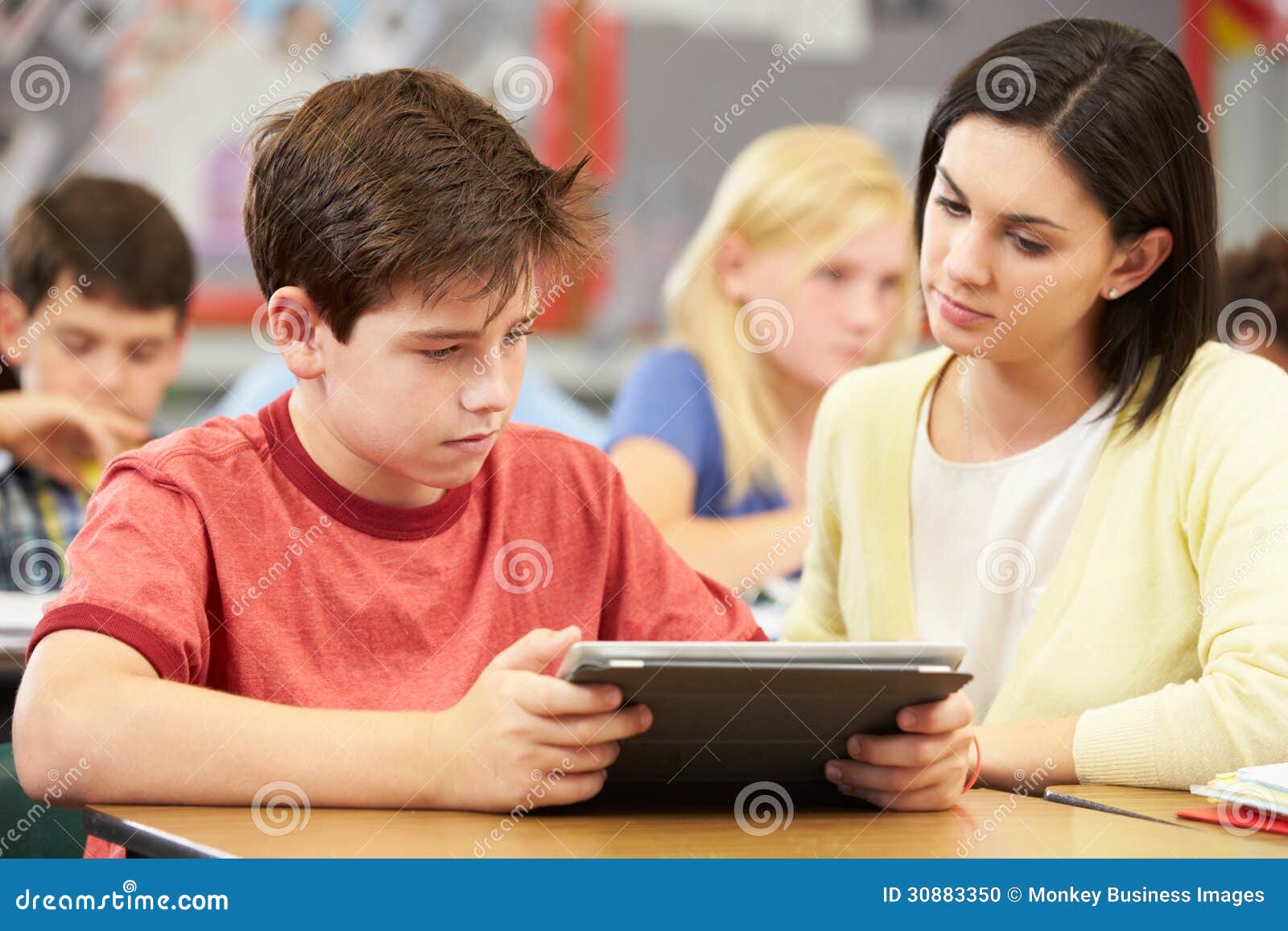 Pupils in Class Using Digital Tablet with Teacher Stock Photo - Image ...
