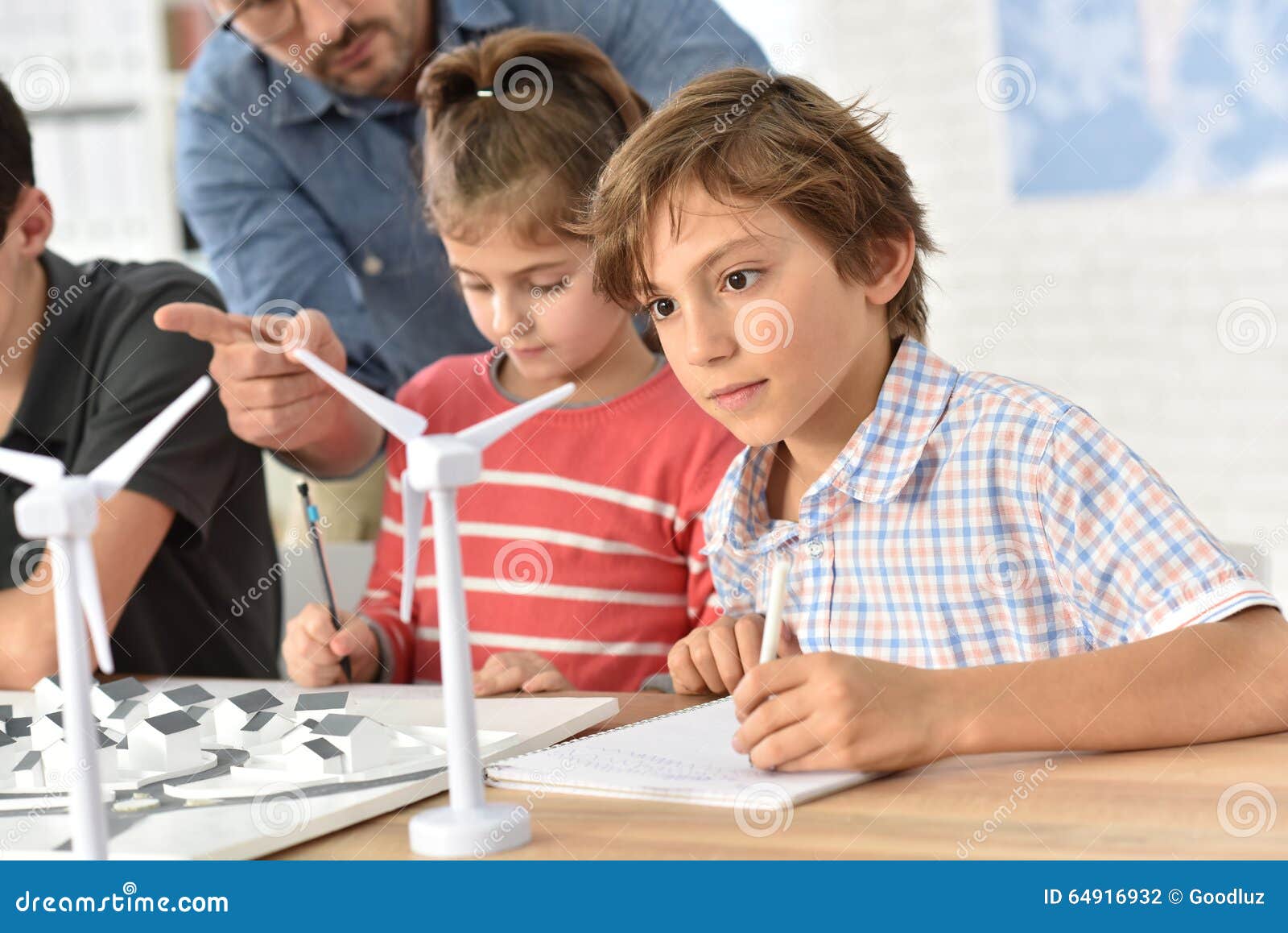 Pupils Learning In Classroom. Female And Male Students Sitting At Desks ...