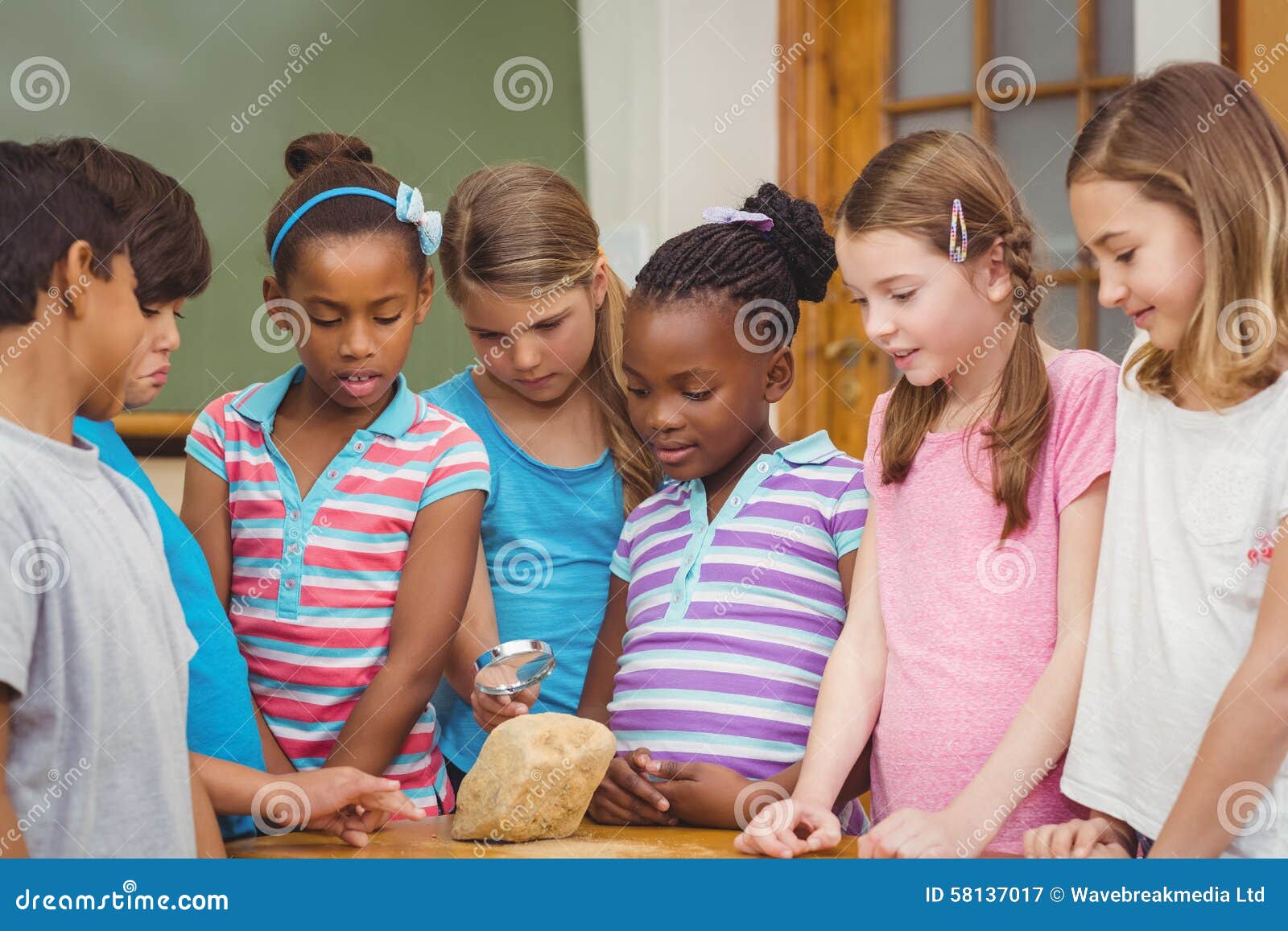 Pupils Looking at Rock with Magnifying Glass Stock Image - Image of ...