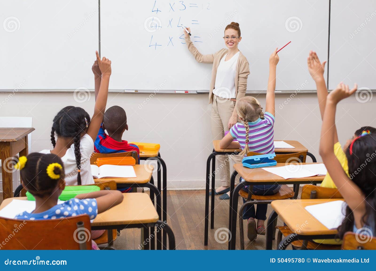 Pupils Raising Hand in Classroom Stock Photo - Image of group ...