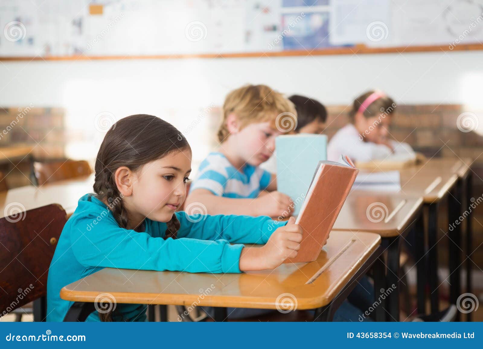 Pupils Sitting in Classroom Reading Books Stock Photo - Image of view ...