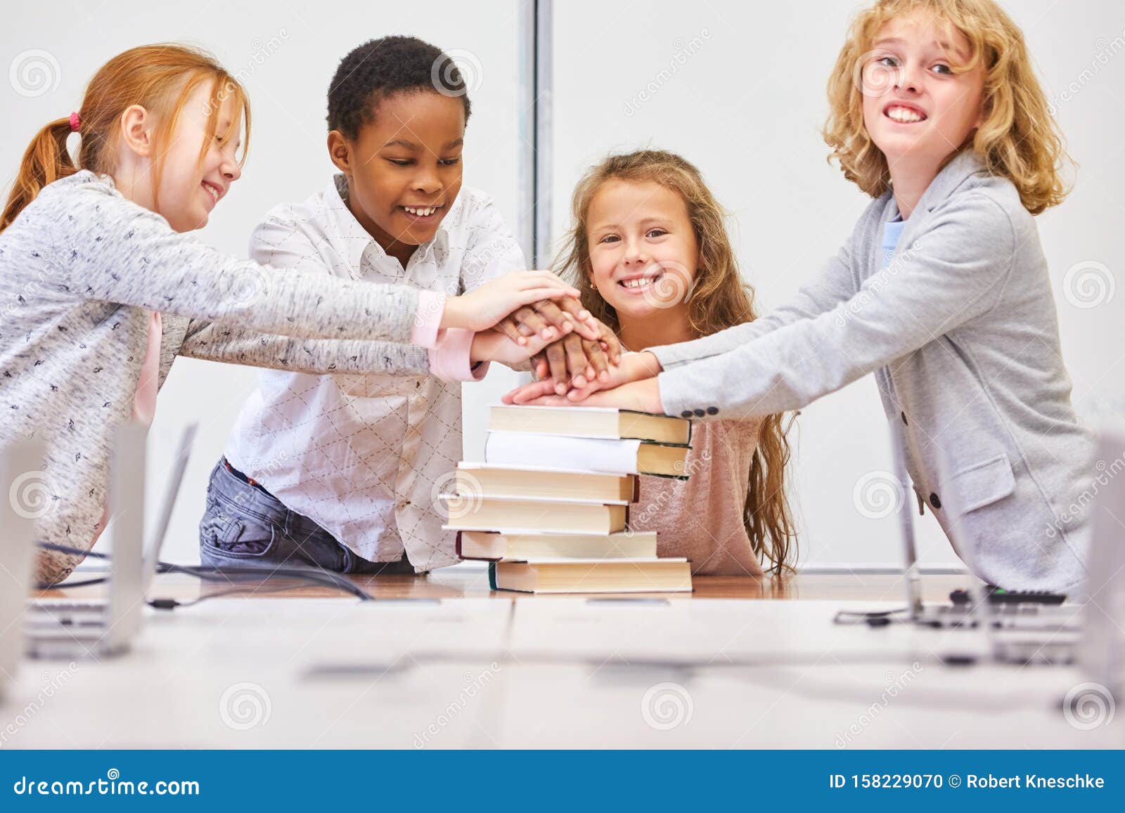 Pupils Stack Hands Together in the Classroom for Motivation Stock Photo ...
