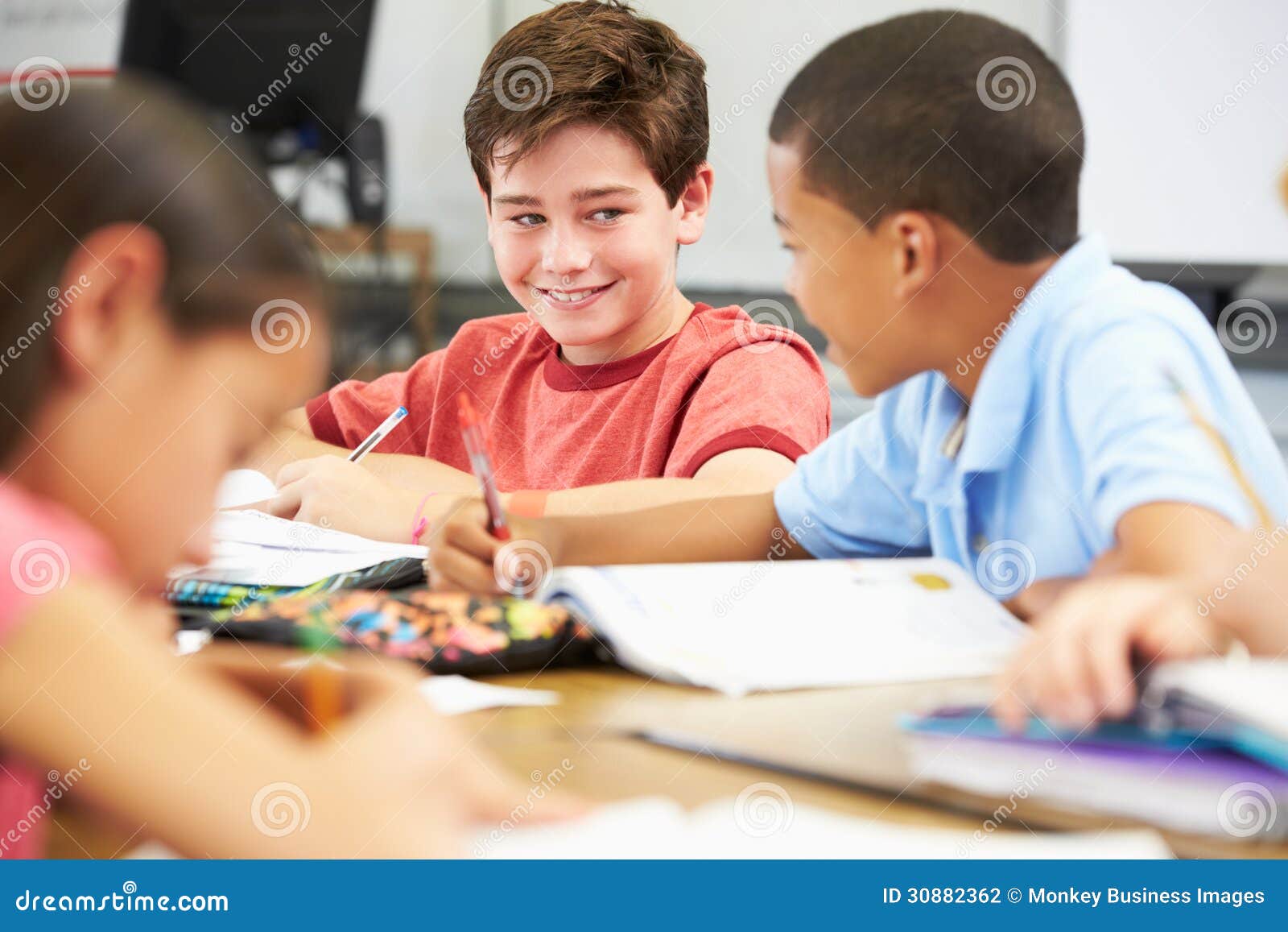 Pupils Studying at Desks in Classroom Stock Photo - Image of student ...
