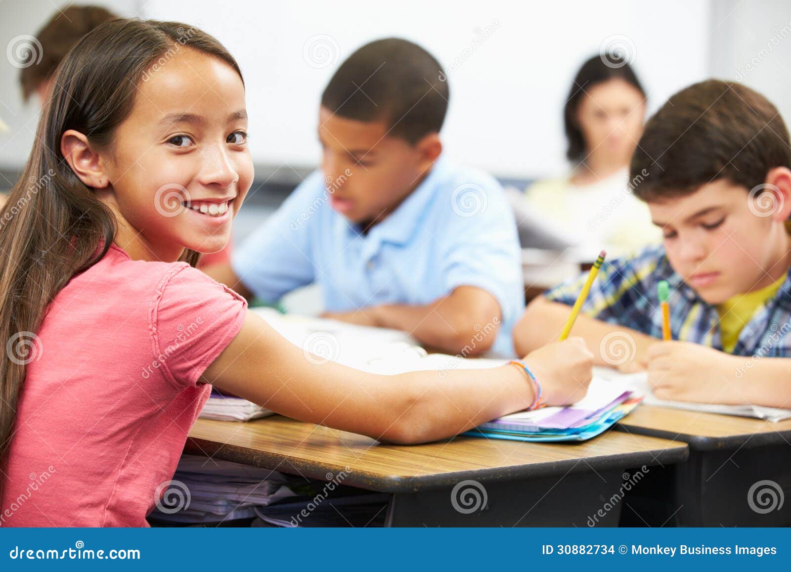 Pupils Studying at Desks in Classroom Stock Photo - Image of people ...