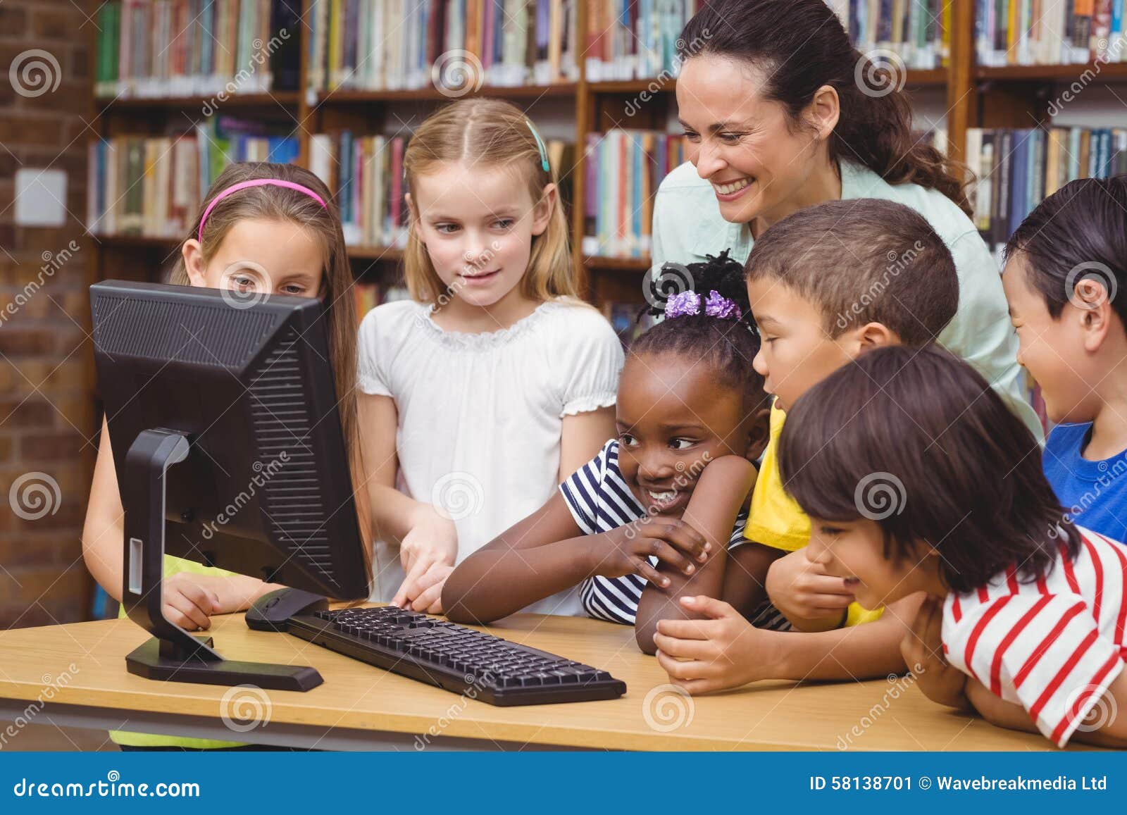 Pupils and Teacher in the Library Using Computer Stock Image - Image of ...