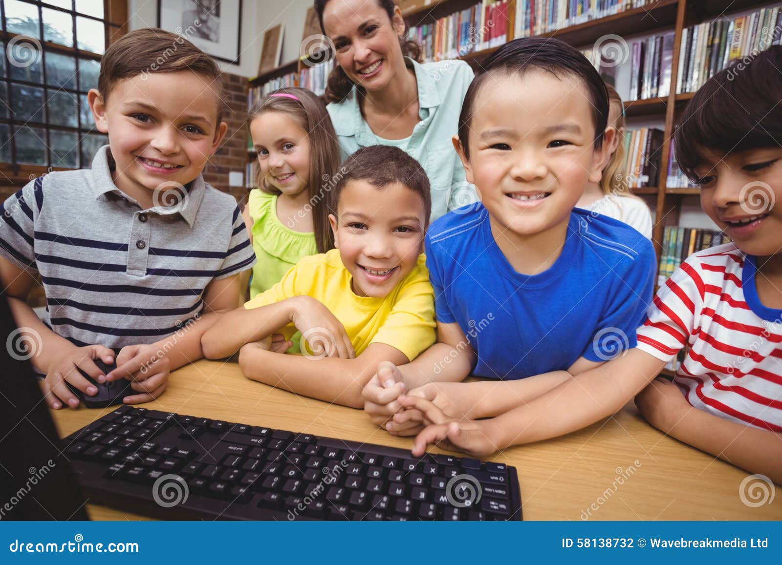 Pupils and Teacher in the Library Using Computer Stock Photo - Image of ...