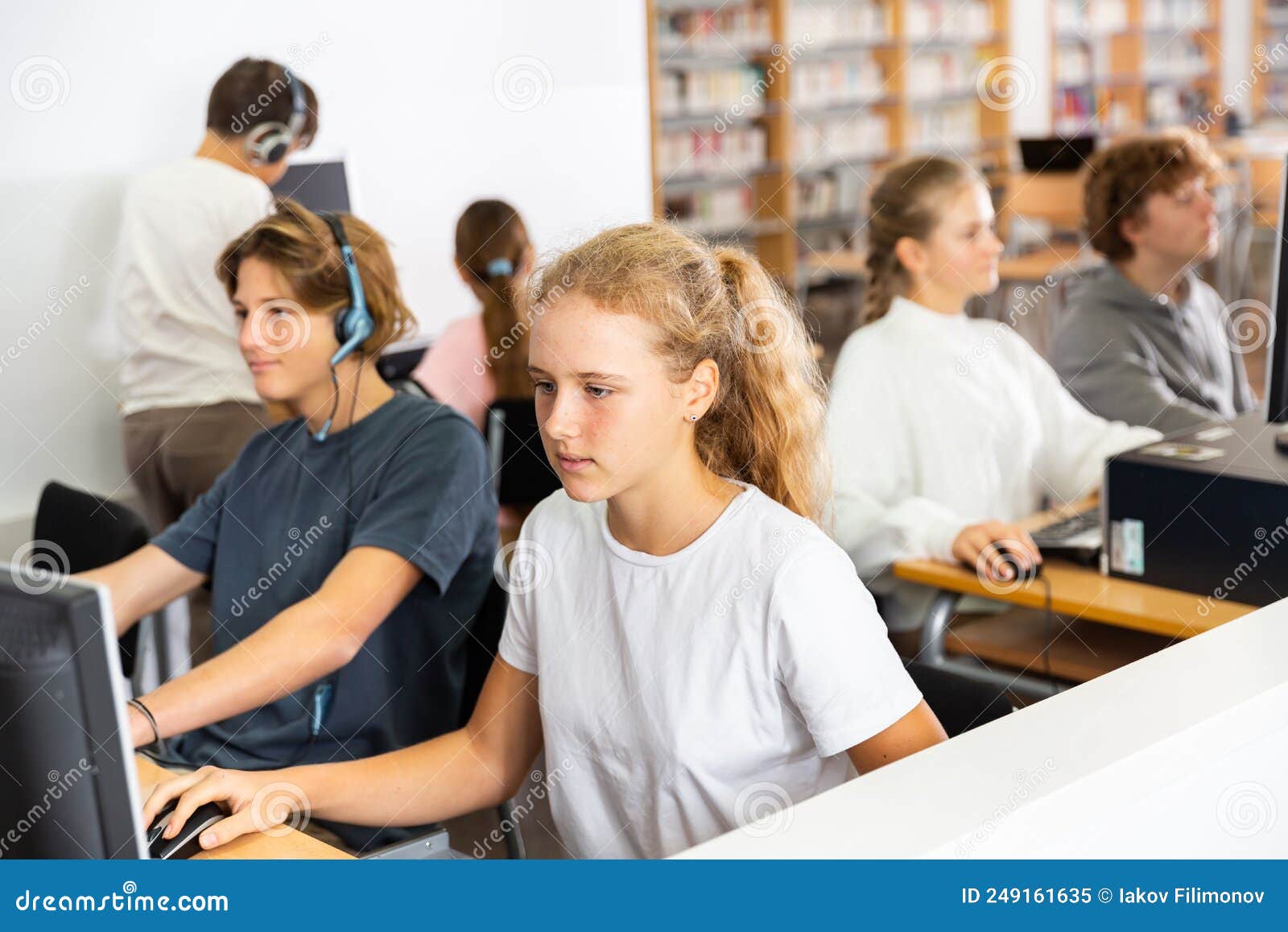 Pupils Using Computers at Lesson, Teacher Teaching Them in Class Room ... Pupils Using Computers at Lesson, Teacher Teaching Them in Class Room ...