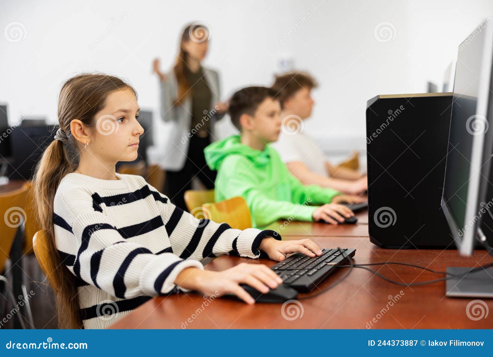 Pupils Using Computers at Lesson, Teacher Teaching Them in Class Room ... Pupils Using Computers at Lesson, Teacher Teaching Them in Class Room ...