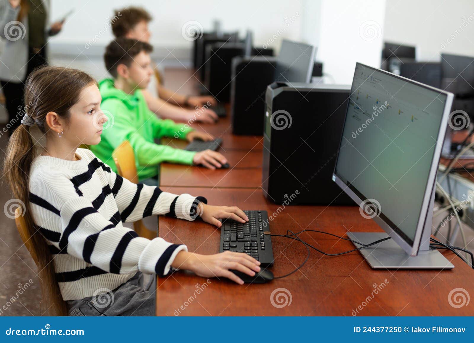 Pupils Using Computers at Lesson, Teacher Teaching Them in Class Room ... Pupils Using Computers at Lesson, Teacher Teaching Them in Class Room ...