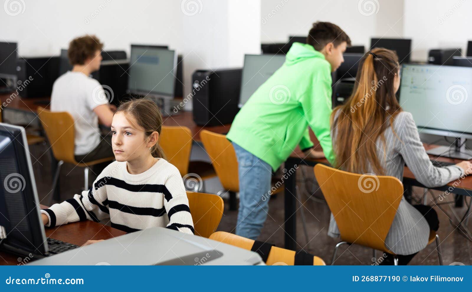 Pupils Using Computers at Lesson, Teacher Teaching Them in Class Room ... Pupils Using Computers at Lesson, Teacher Teaching Them in Class Room ...