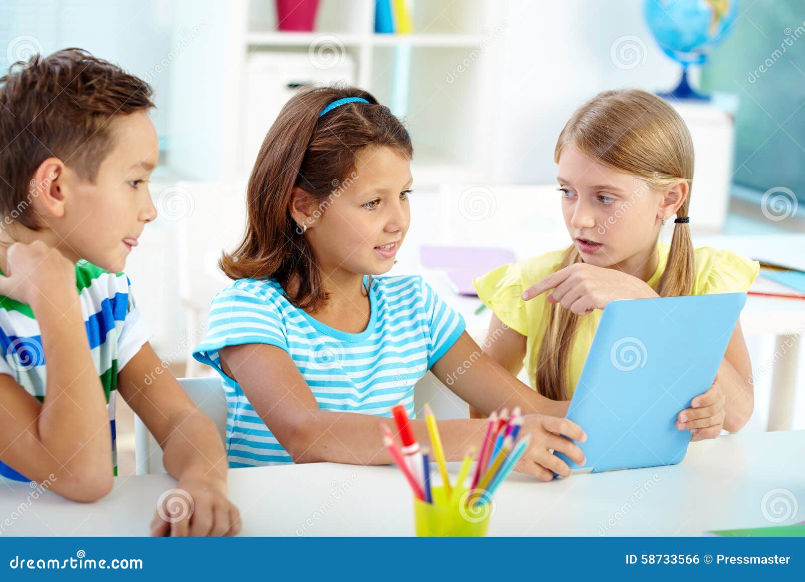 Pupils using touchpad stock photo. Image of junior, handsome - 58733566