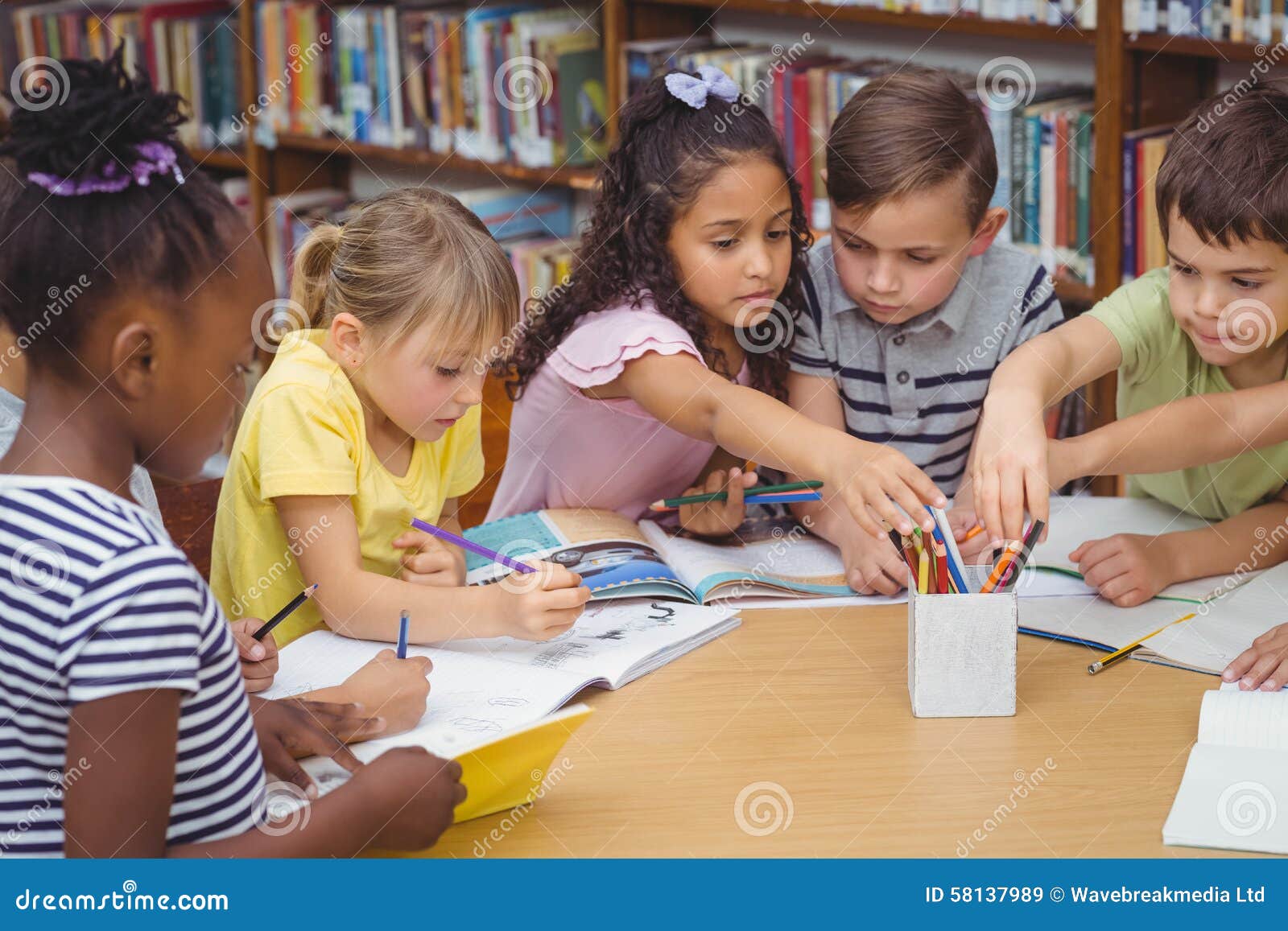 Pupils Working Together at Desk in Library Stock Image - Image of ...