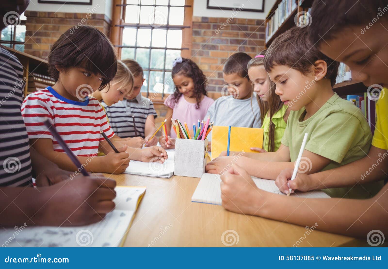 Pupils Working Together at Desk in Library Stock Image - Image of black ... Pupils Working Together at Desk in Library Stock Image - Image of black ...
