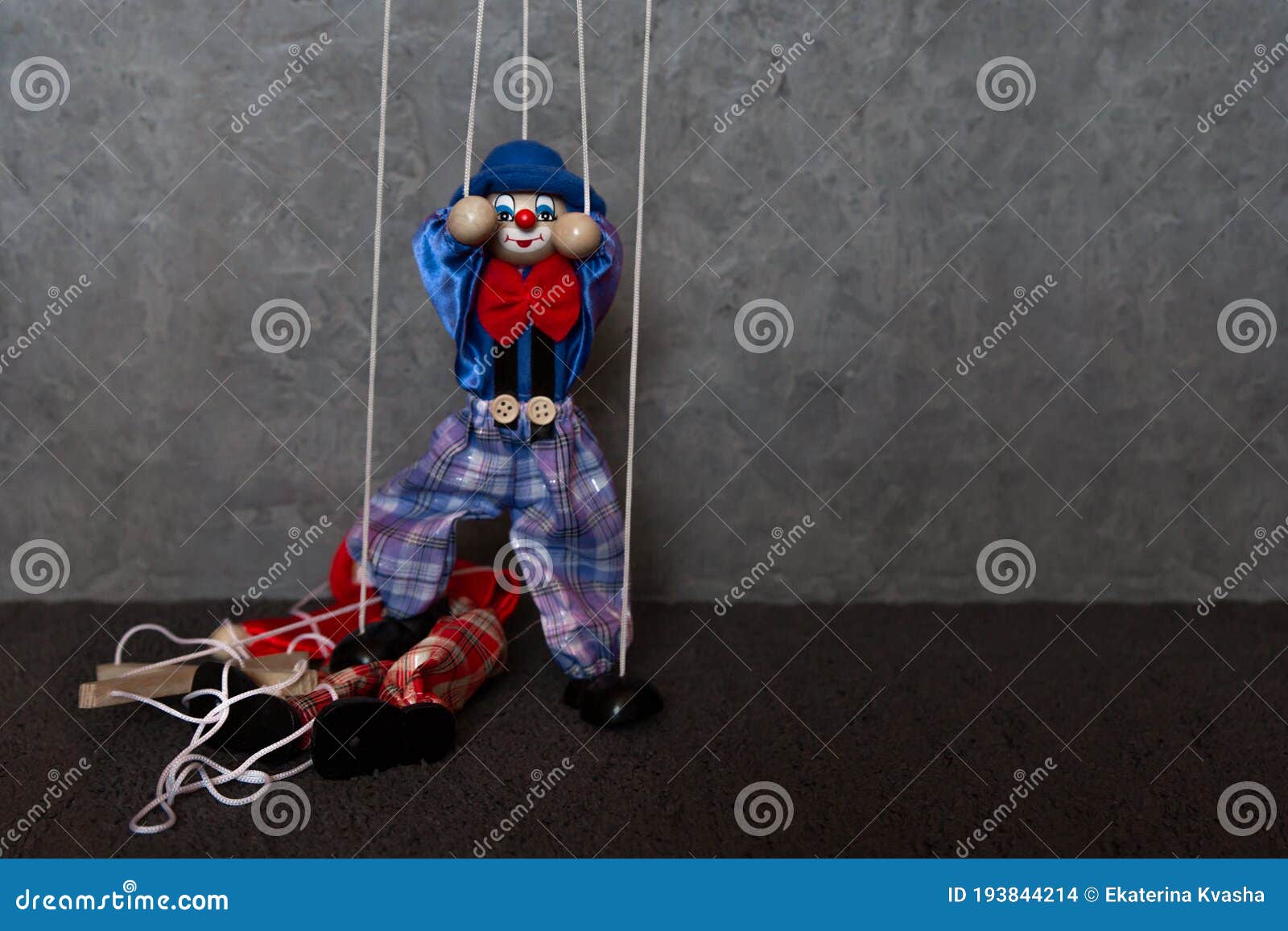A Puppet-clown, Entangled In Threads And Lying Limp Stock Photo ...