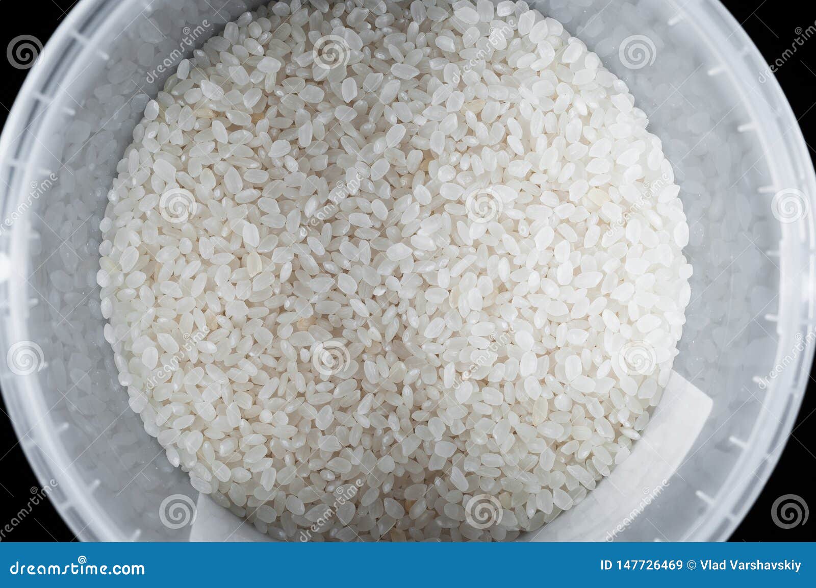 Pure White Rice in a Plastic Bucket on a Black Background, Isolate ...