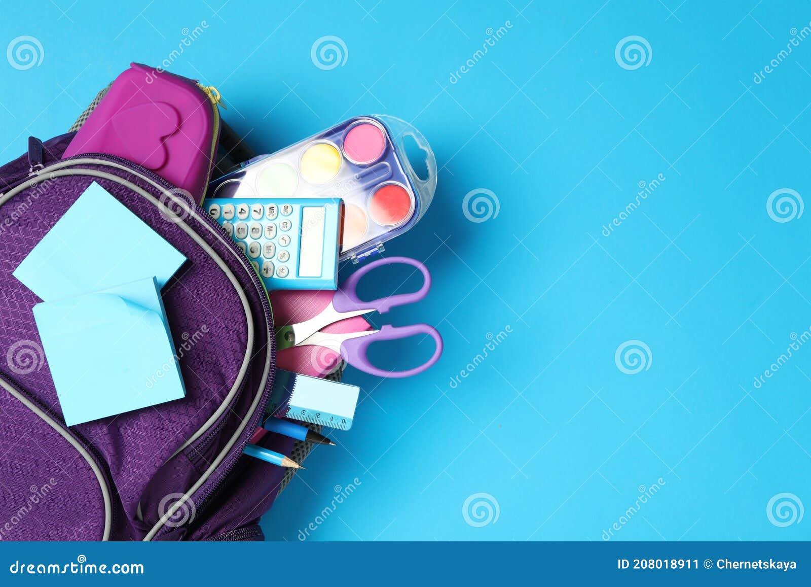 Purple Backpack with Different Stationery on Light Blue Background, Top ...