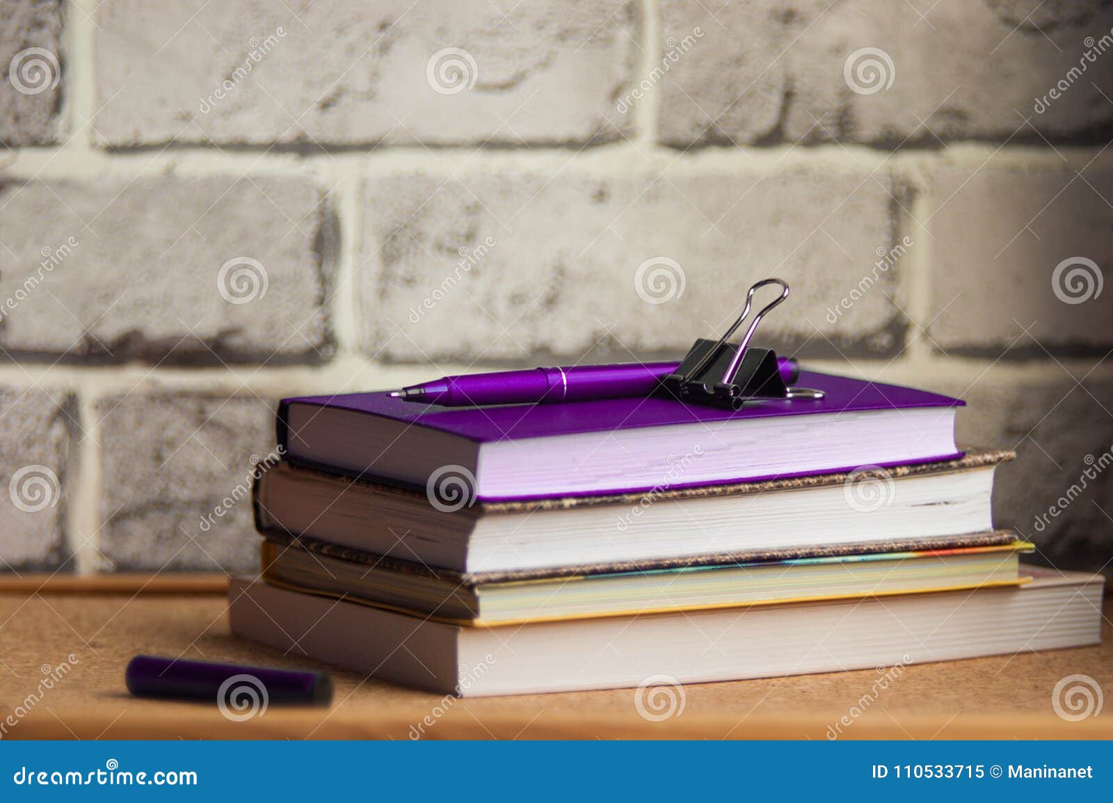 The Purple Handle Rests On A Purple Diary, A Stack Of Planings, A Black ...