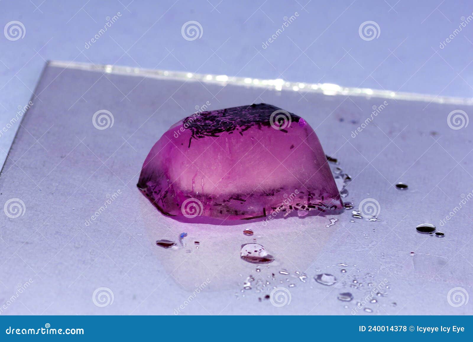 Purple Ice Cube on Glass on a Blue Background Stock Photo - Image of ...