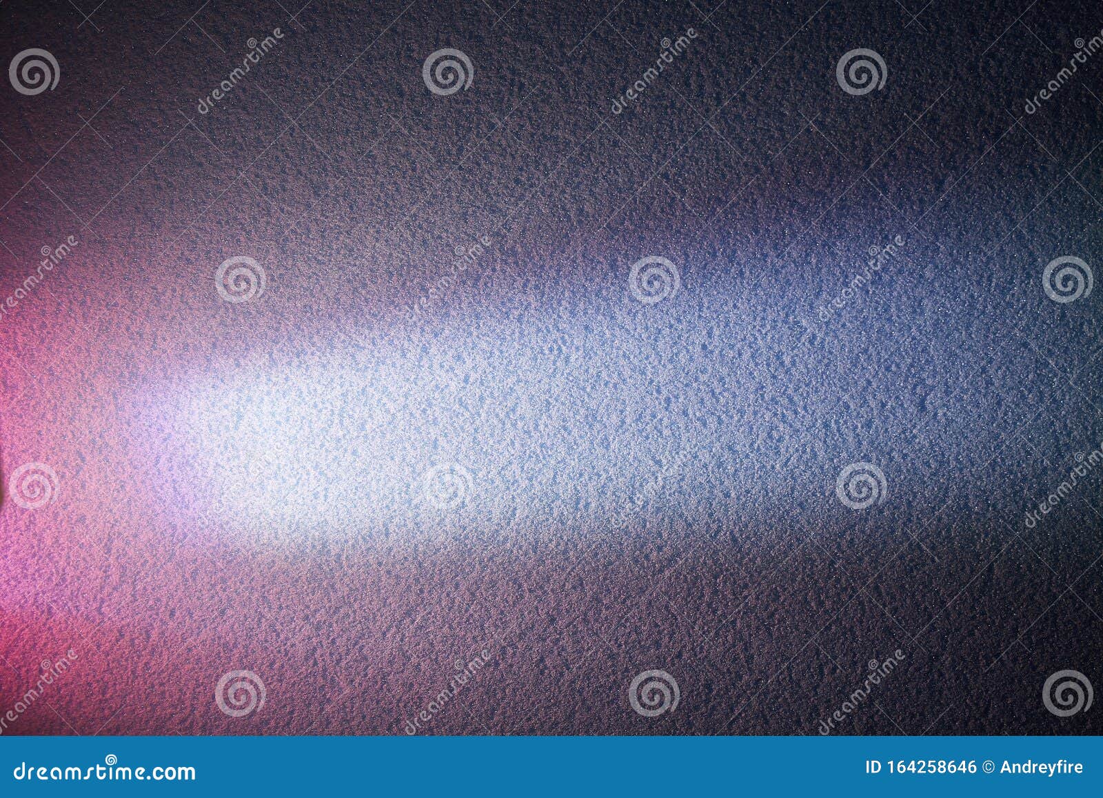 On a Purple Textural Background, a Bright Ray of Light and a Pink Glow ...